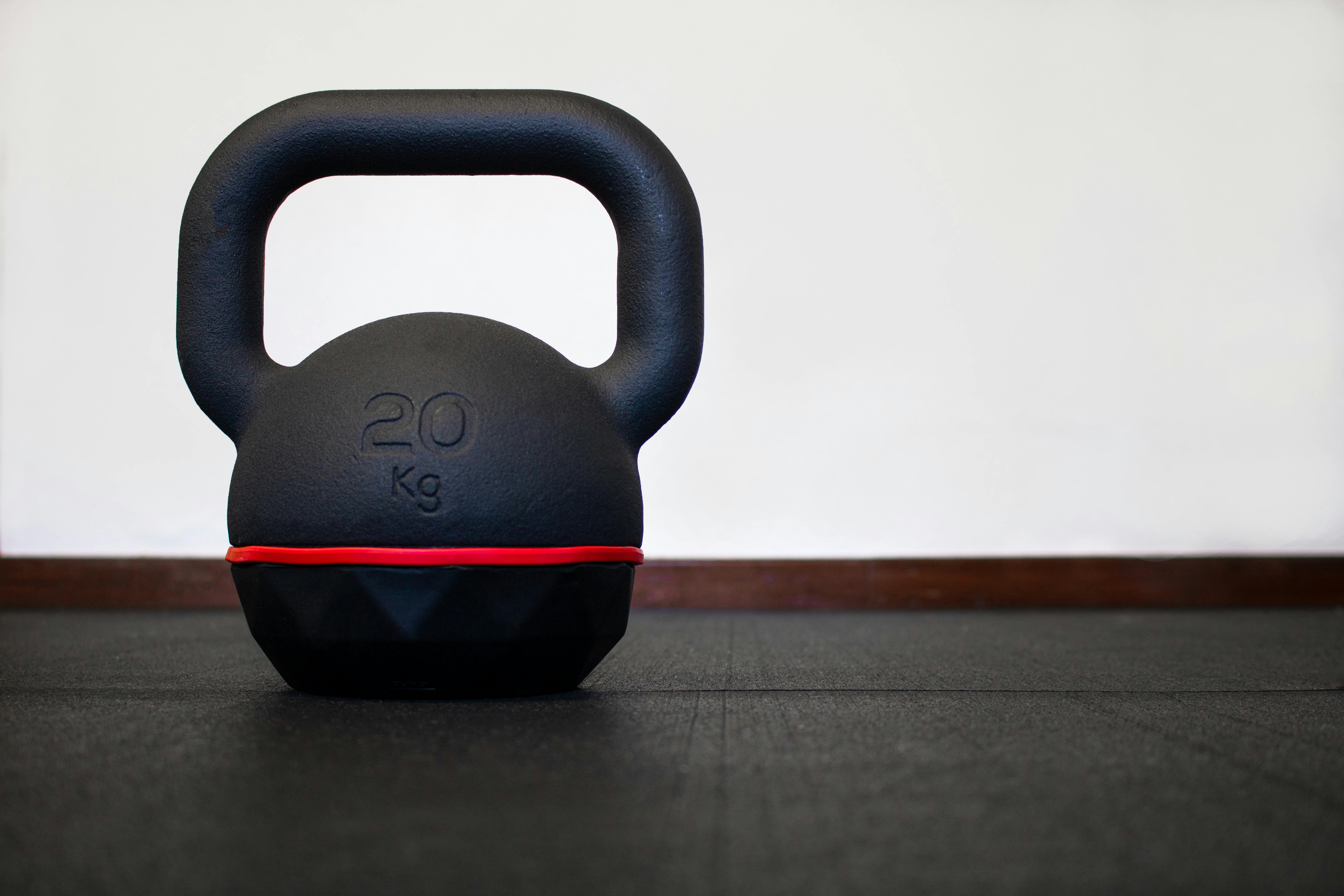 Close-up of 20Kg black kettlebell isolated on the floor at the gym ...