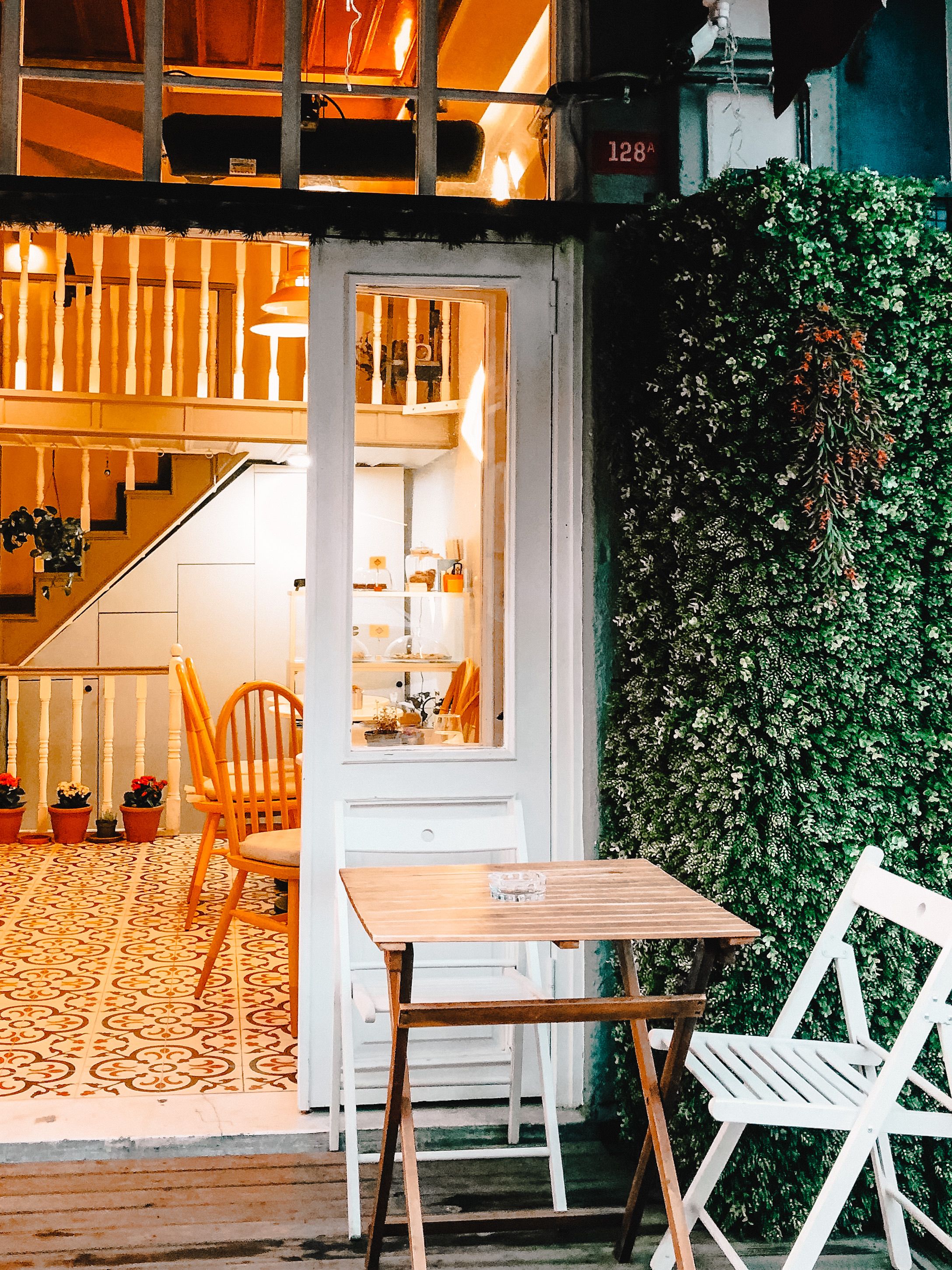 Table and Chair in front of the Entrance to a Cafe · Free Stock Photo