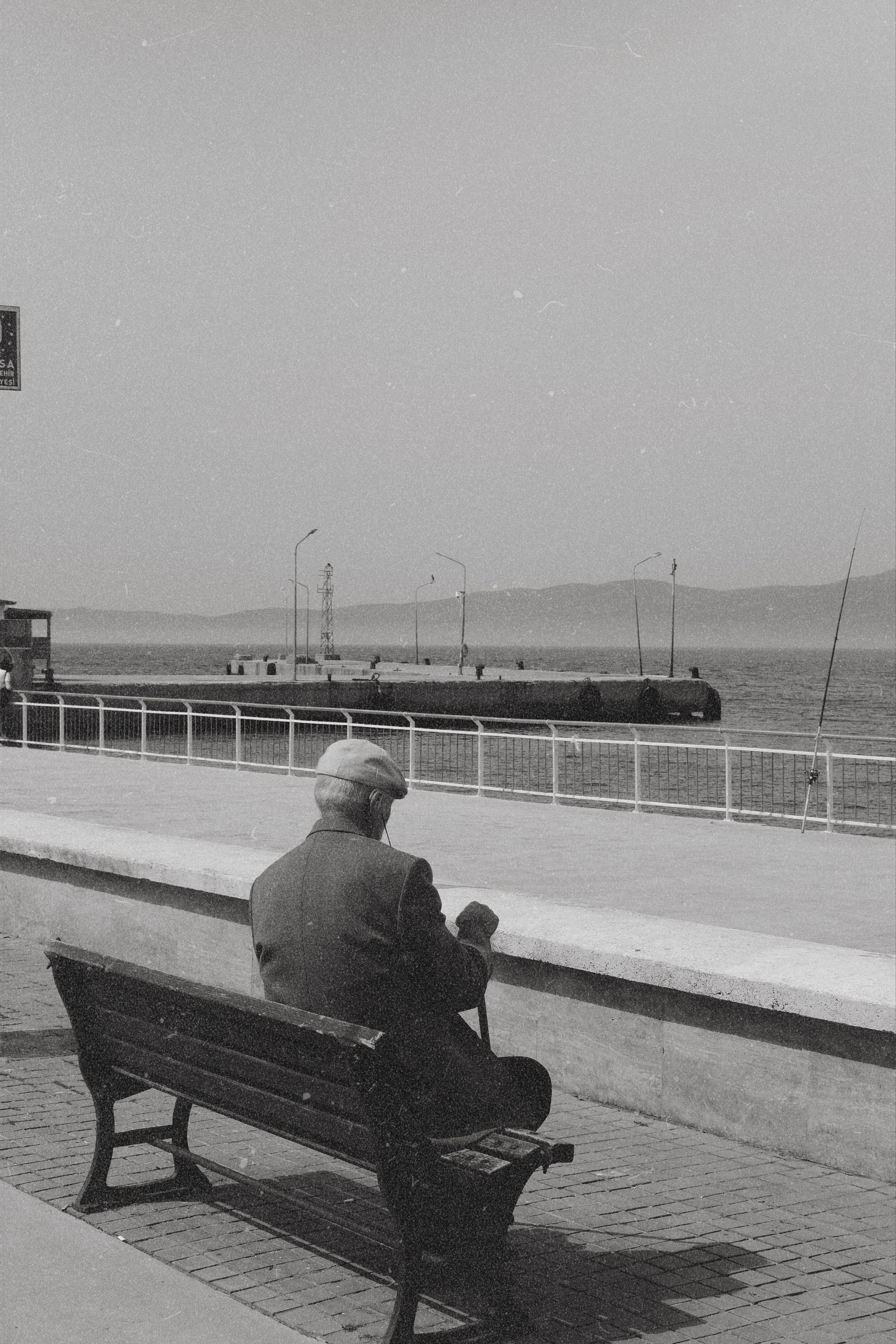 Elderly Man on Bench in Seaside · Free Stock Photo