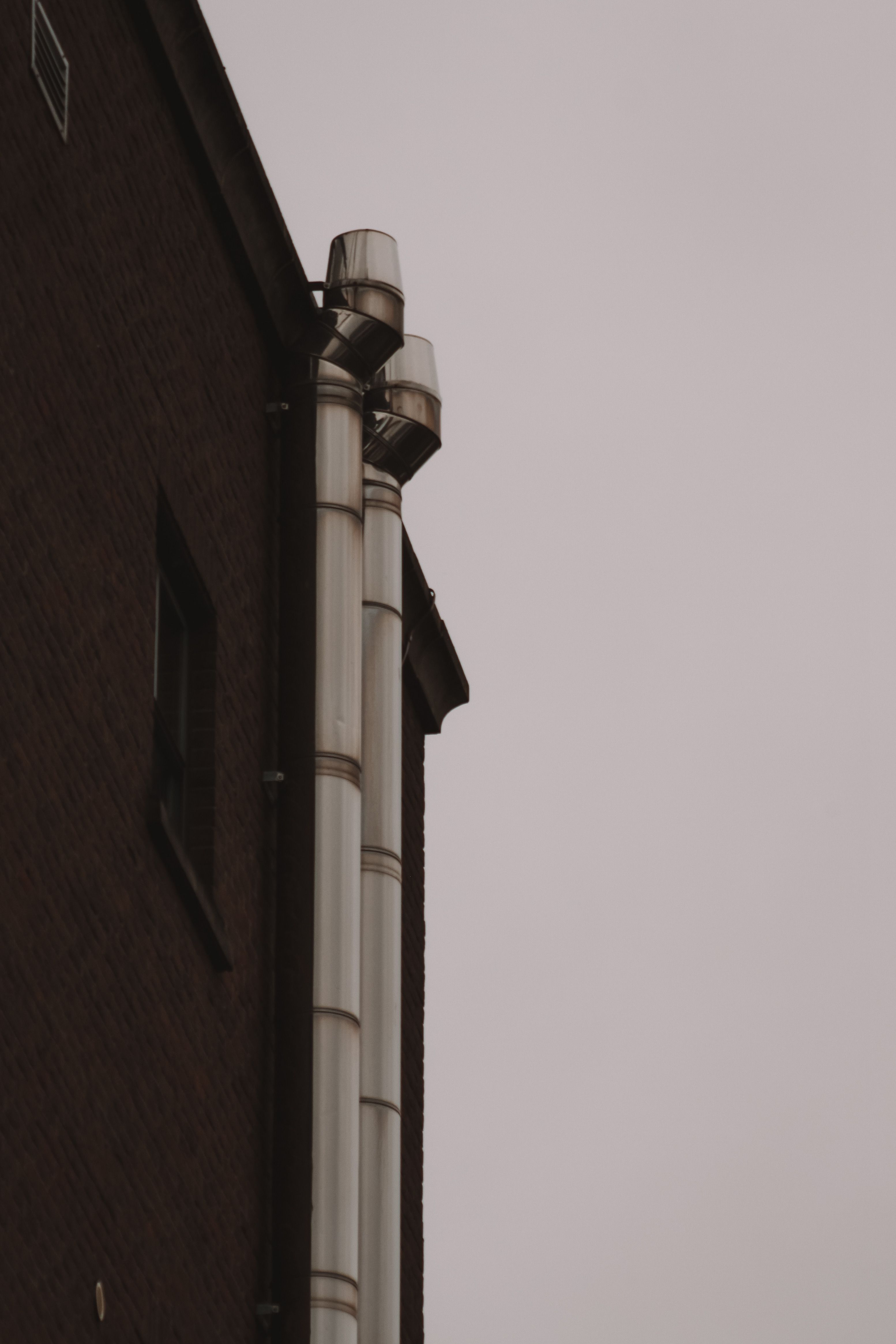 Chimneys on the Wall of a Building · Free Stock Photo