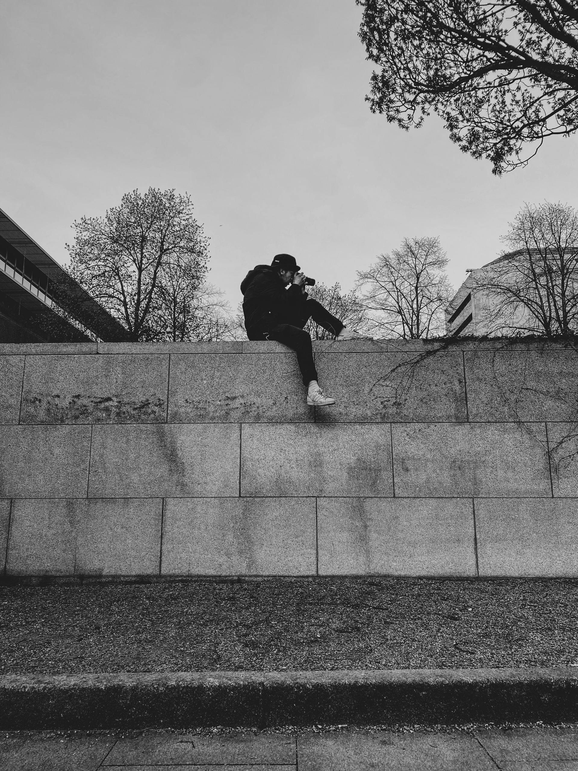 Photo of a Woman Leaning by a Window, Holding a Camera · Free Stock Photo