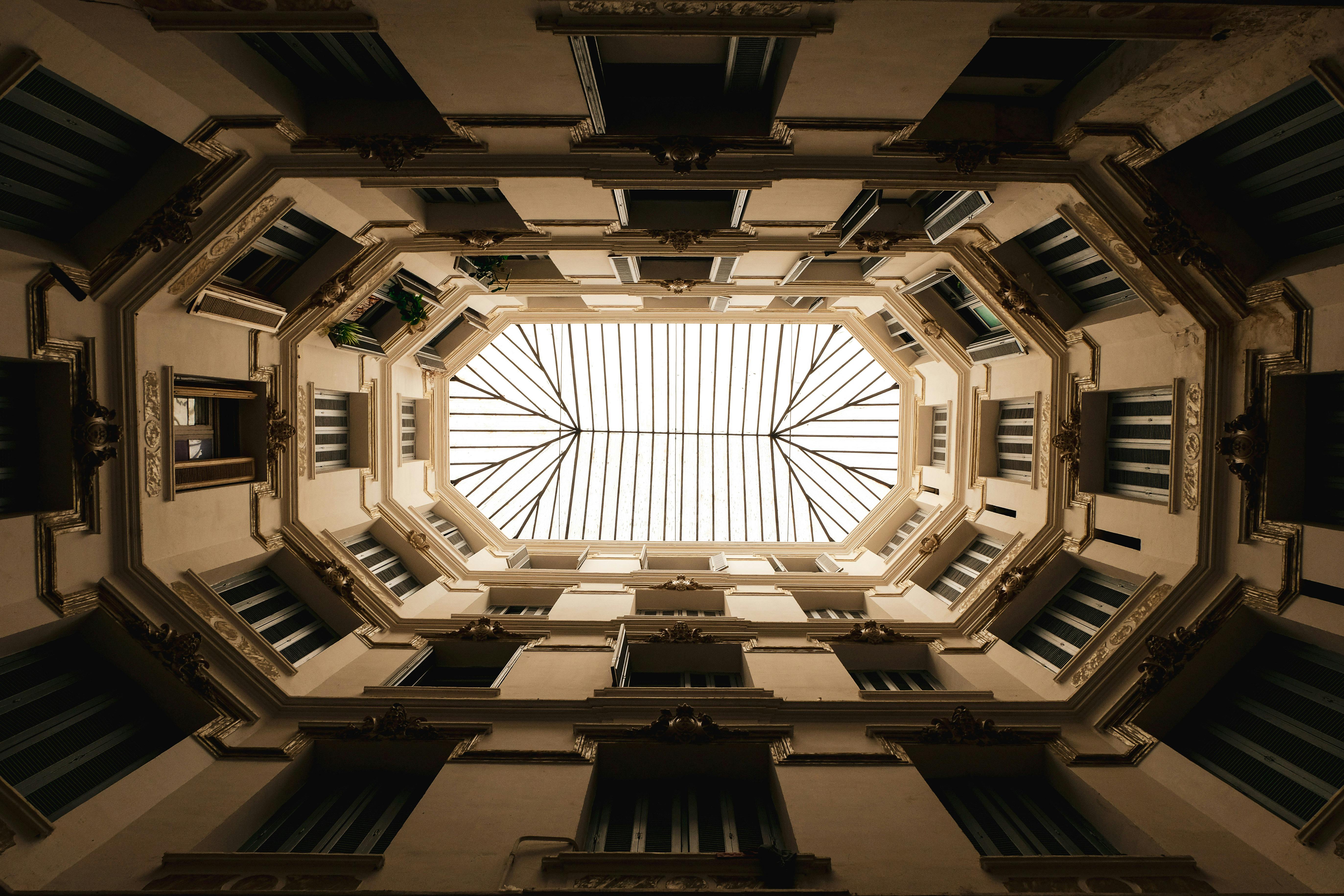 View Below a Glass Roof and Walls with Carved Details · Free Stock Photo