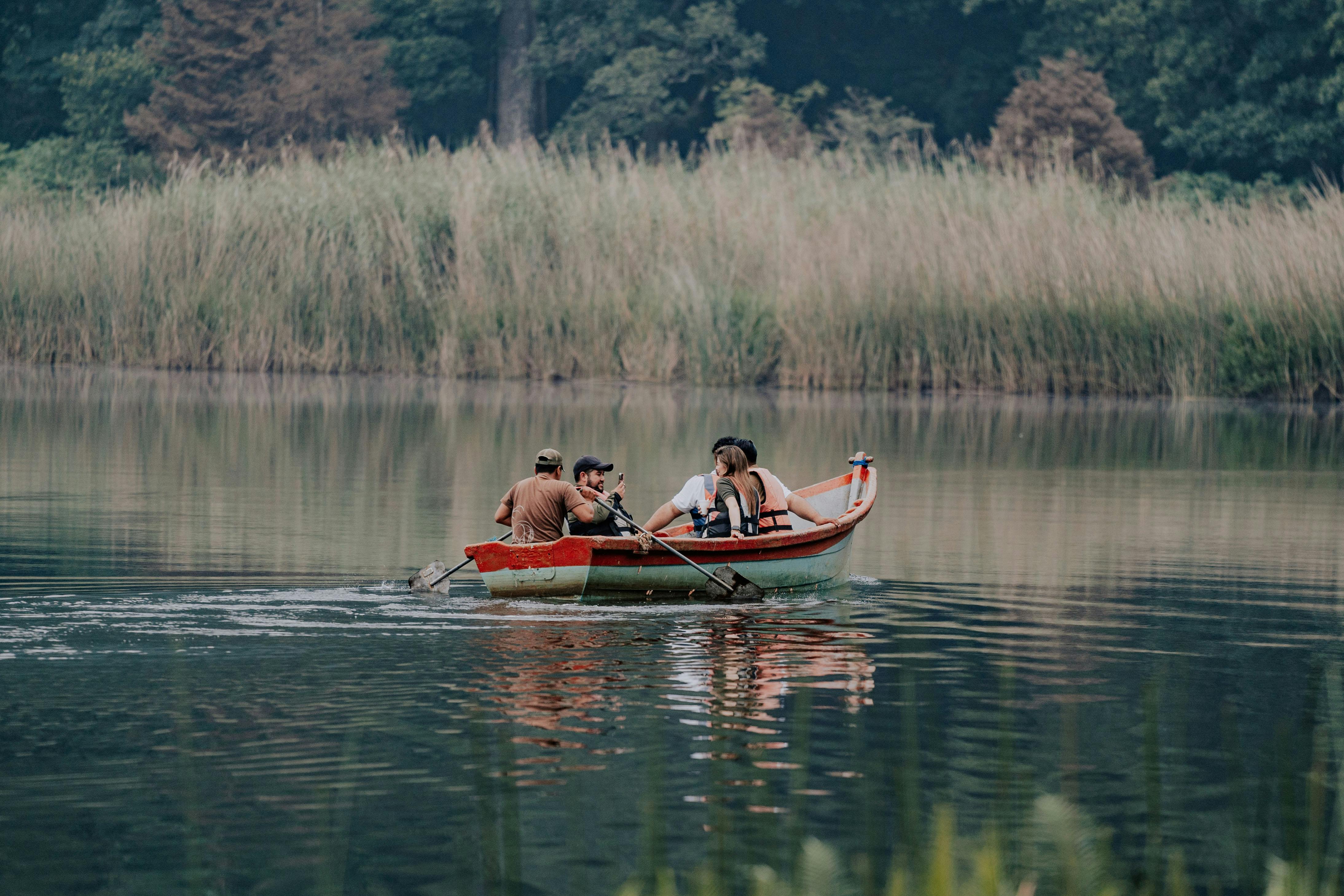 People Swimming on a Boat on Lake · Free Stock Photo