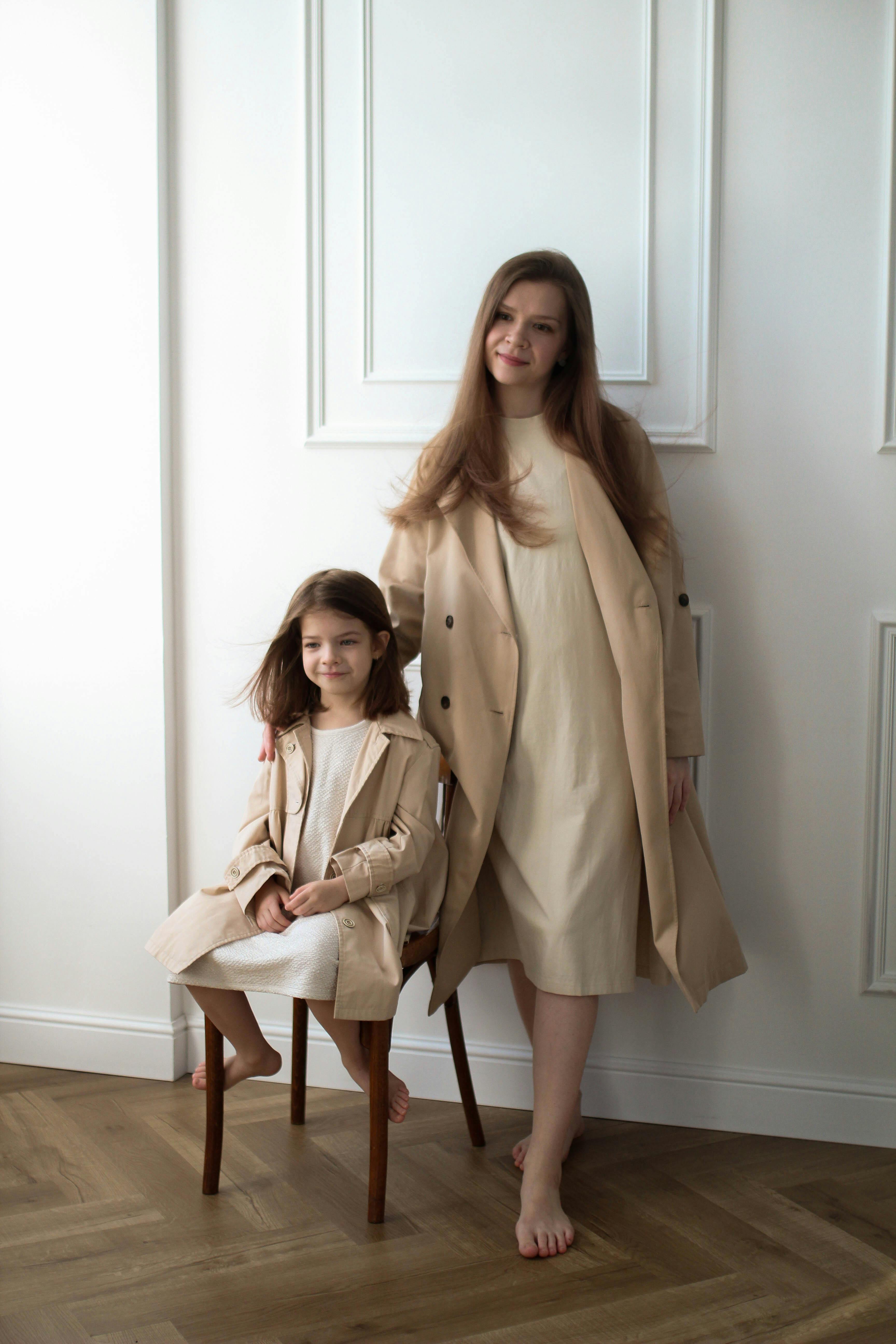 Barefoot Mother and Daughter Posing in Trench Coats · Free Stock Photo