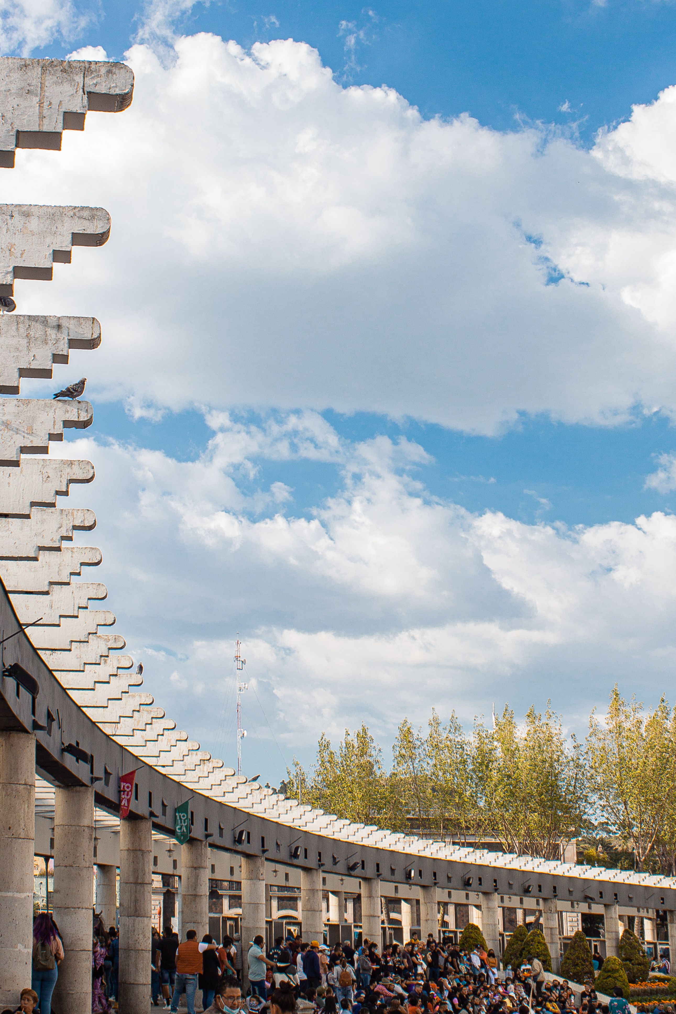 A Crowd by a Concrete Arched Construction · Free Stock Photo