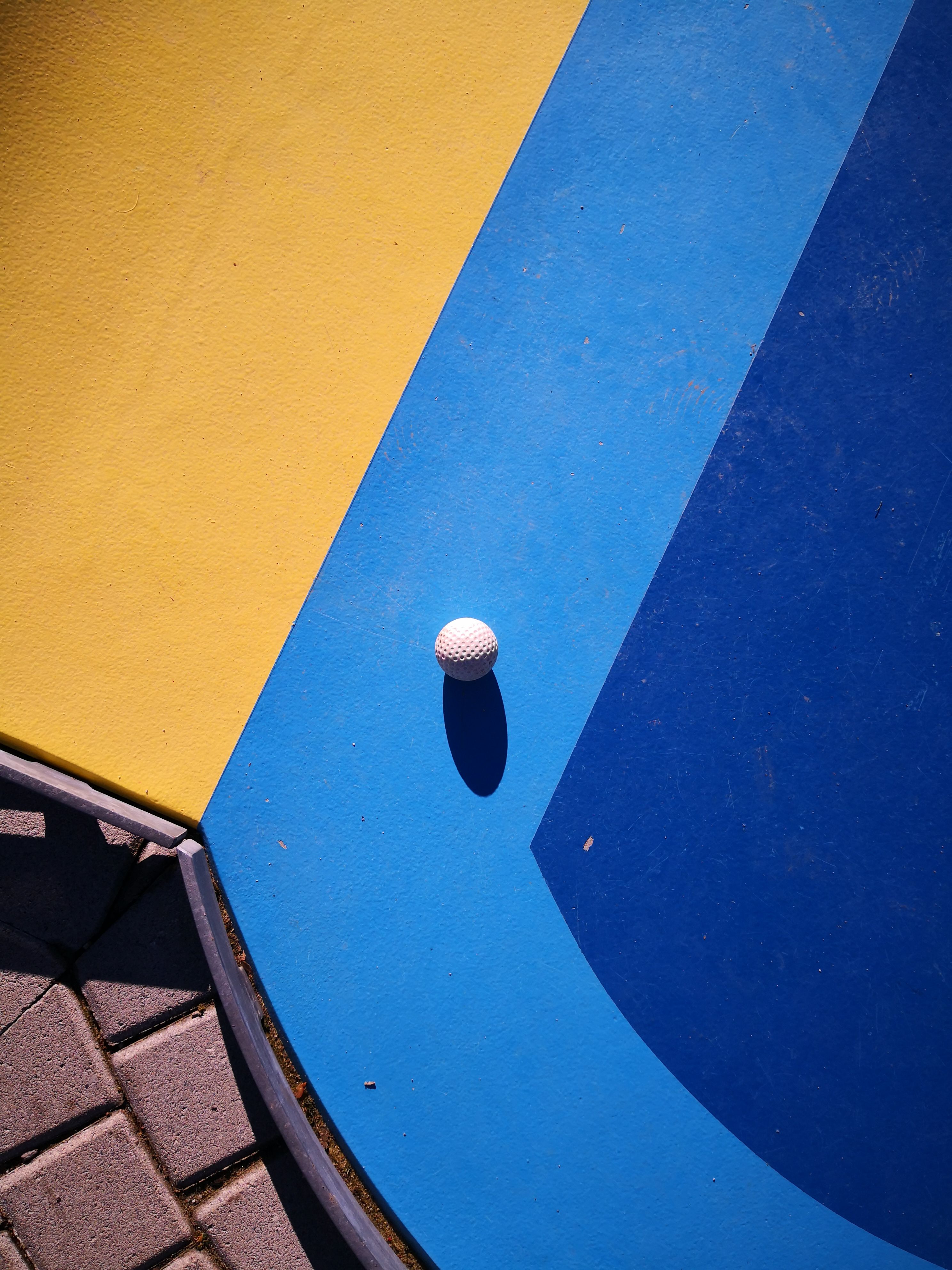 Golf Ball on Blue Ground · Free Stock Photo