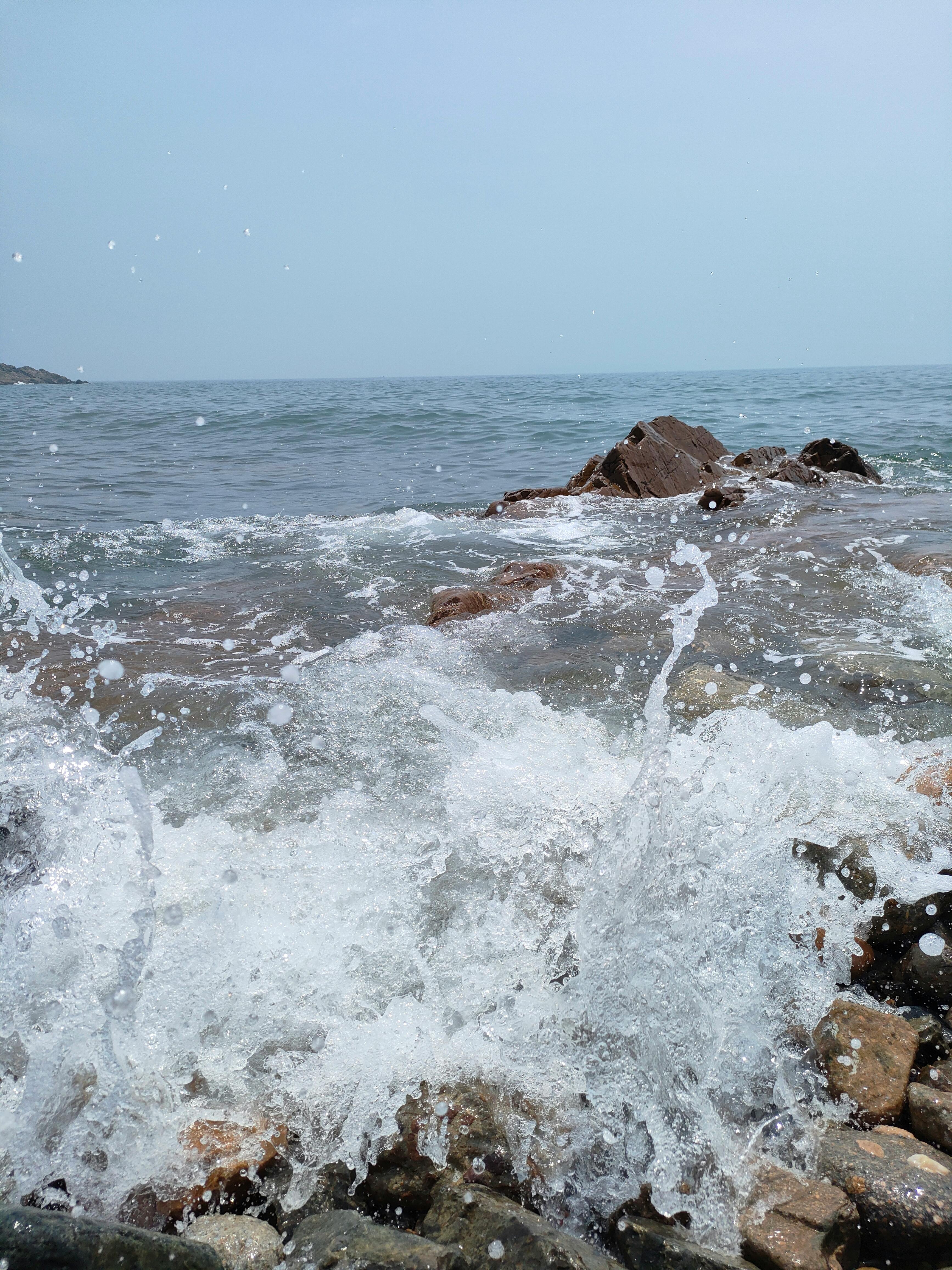 Foamy Surf Waves Splashing on Rocky Seashore · Free Stock Photo