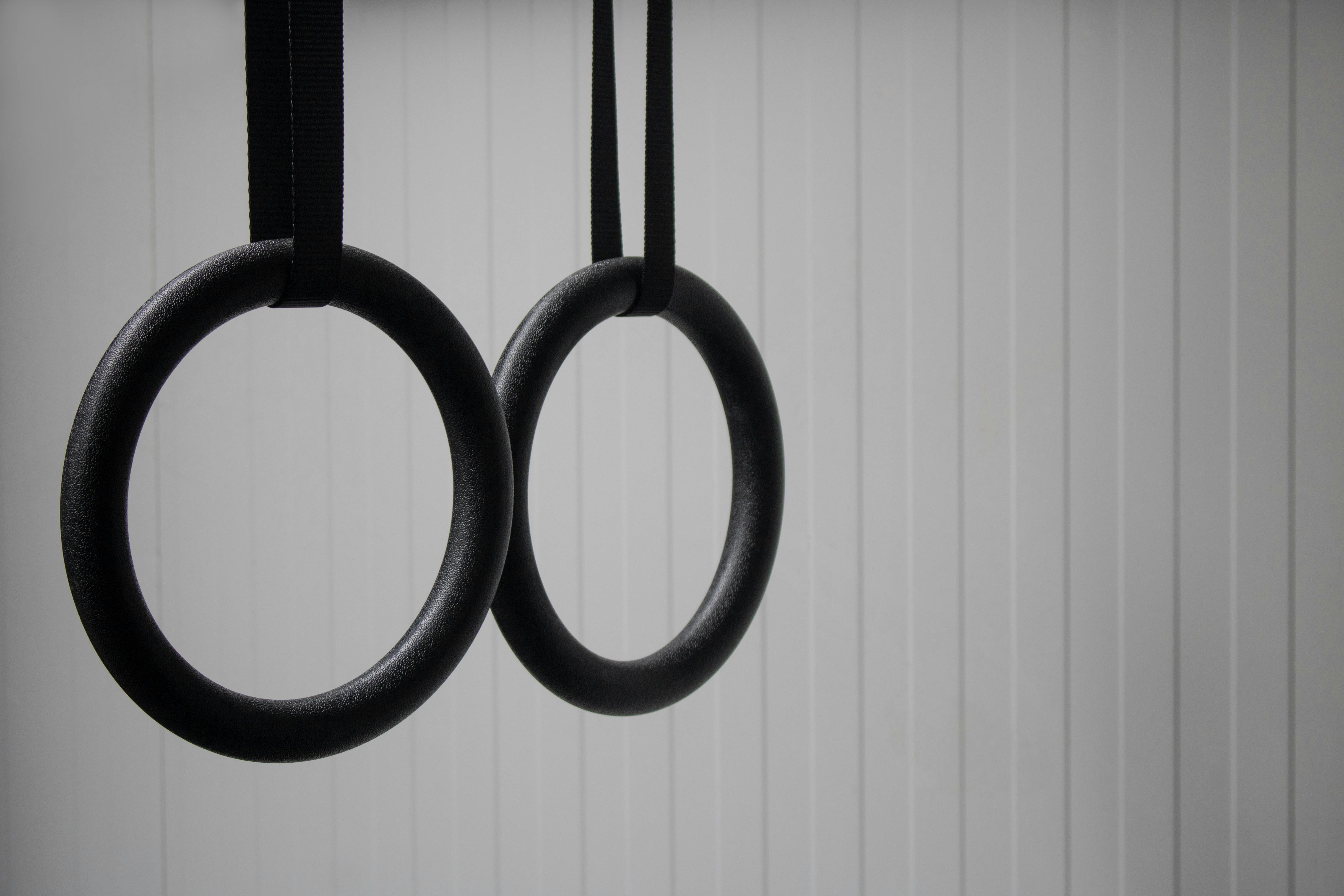 Detail of a set of black gymnastic rings or steady rings hanging in ...