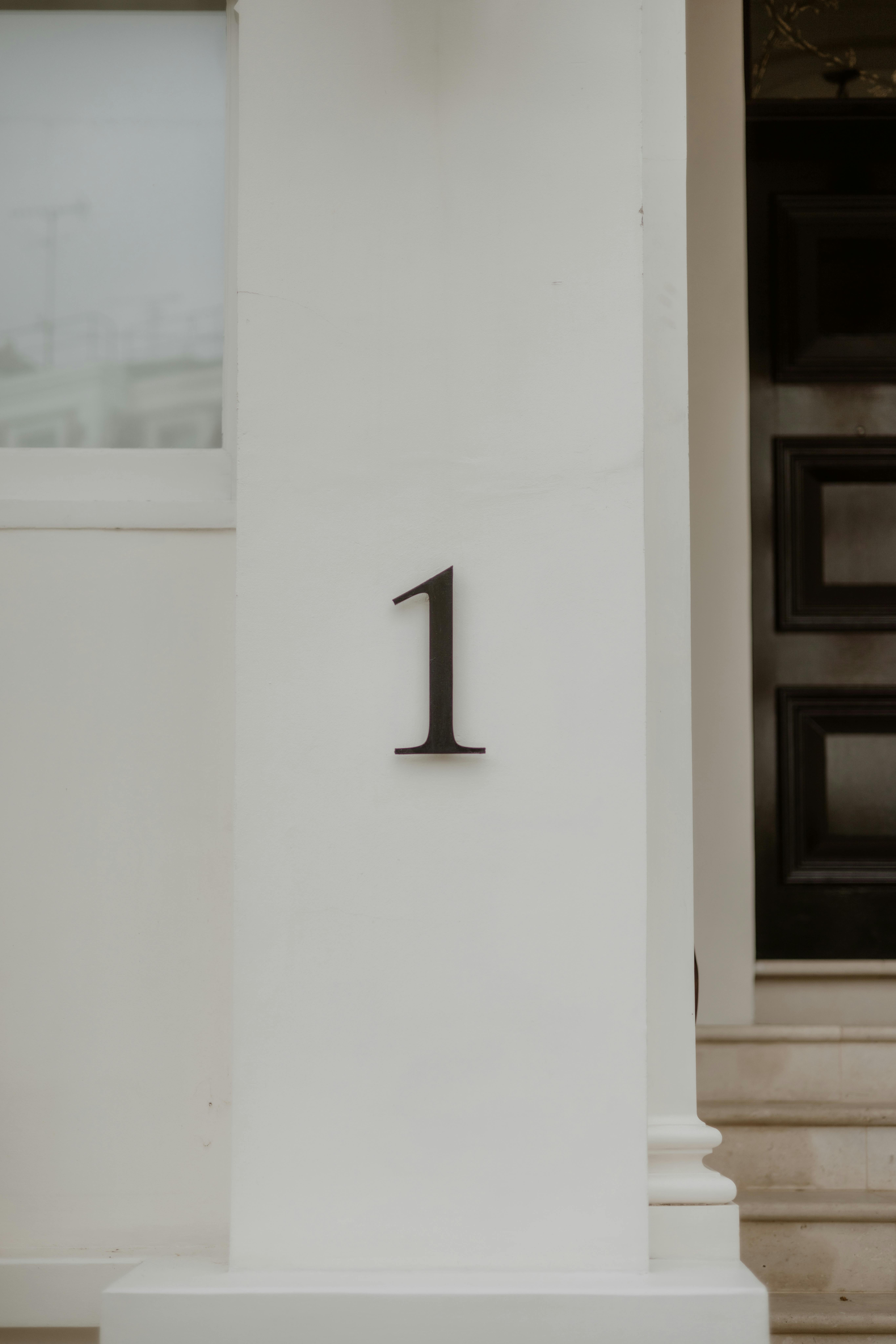 Sign with house number on wall · Free Stock Photo