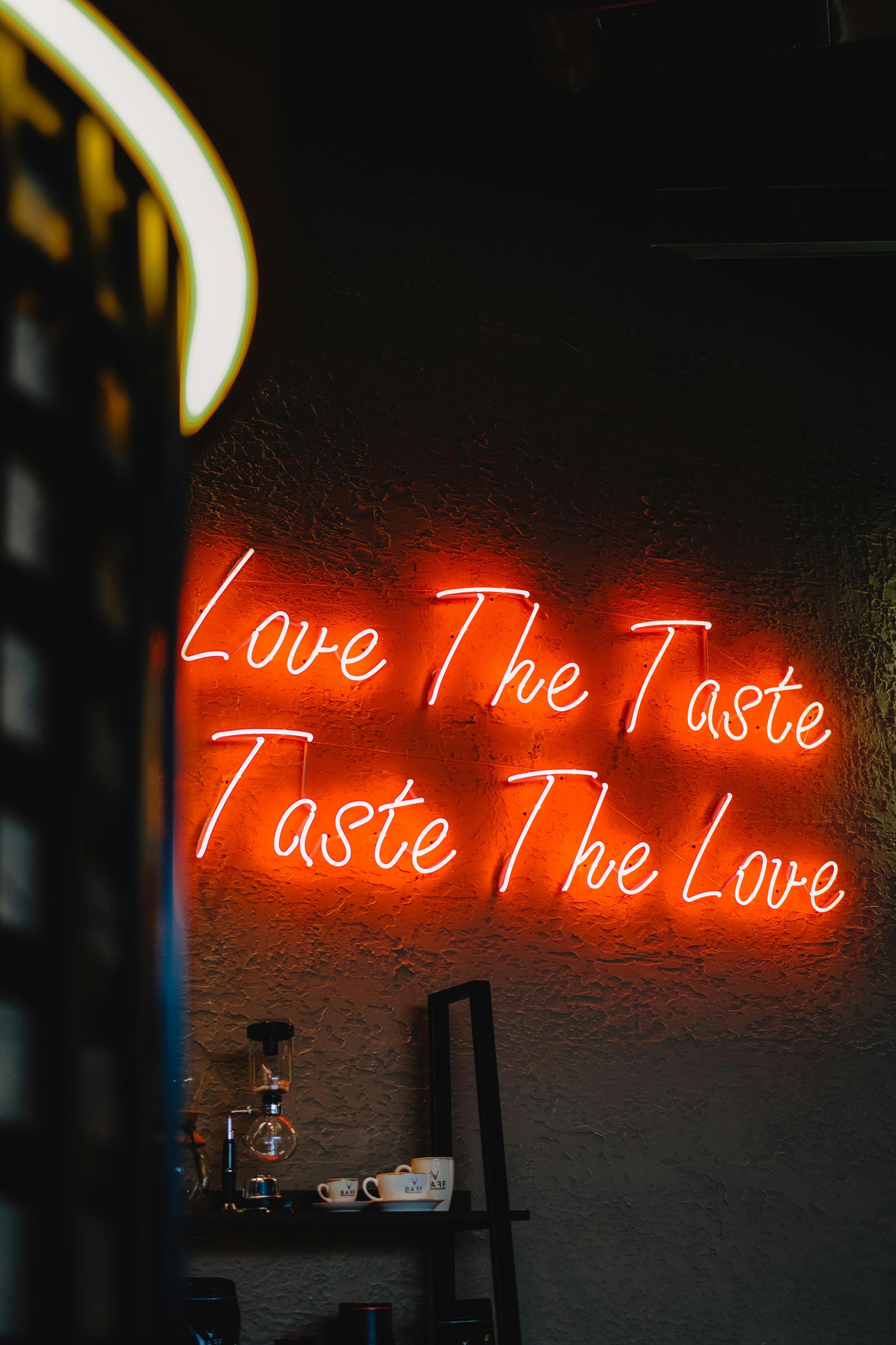 A neon sign that says love the taste, taste the love · Free Stock Photo