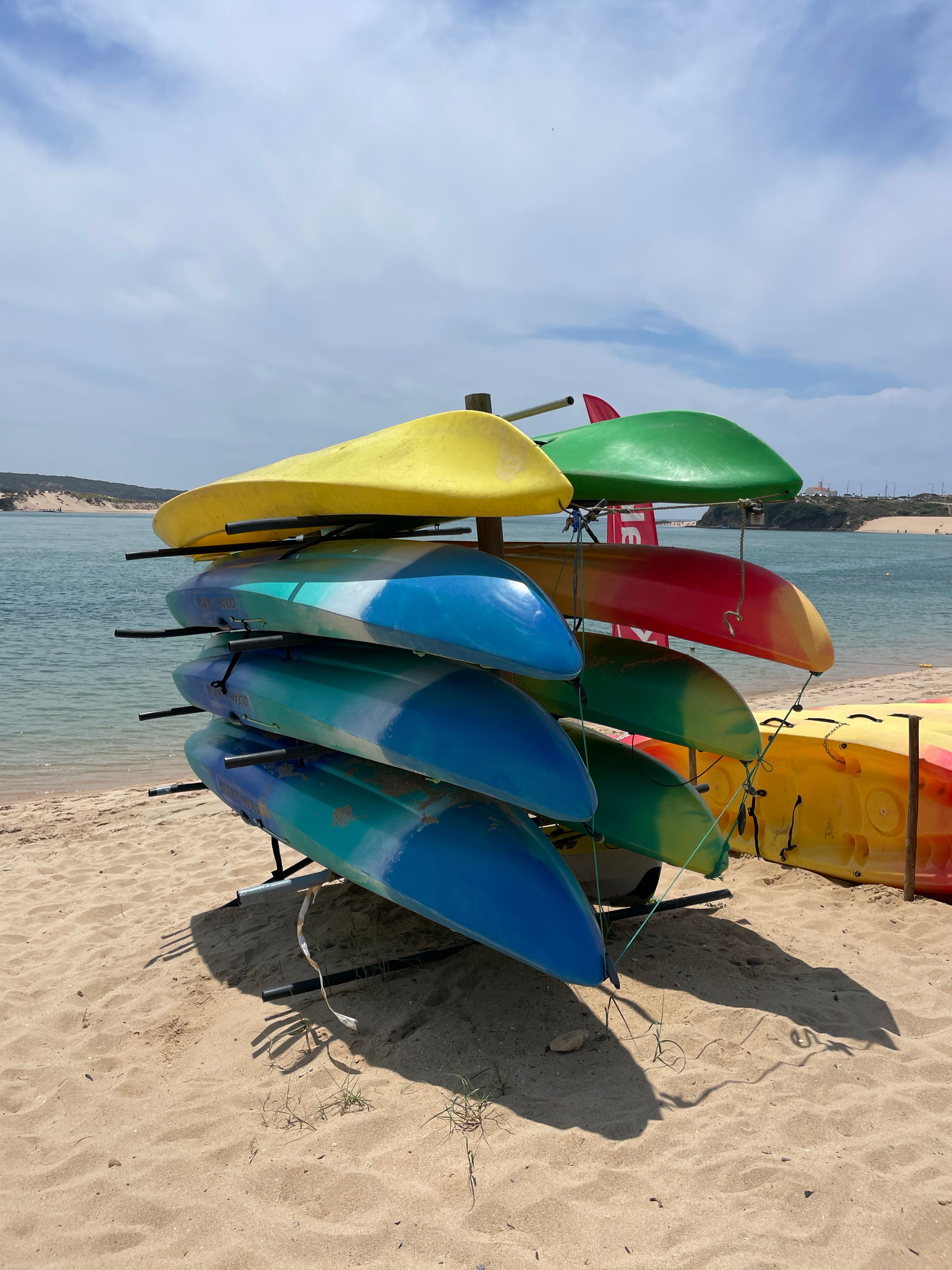 Stand with Multi Colored Kayaks · Free Stock Photo