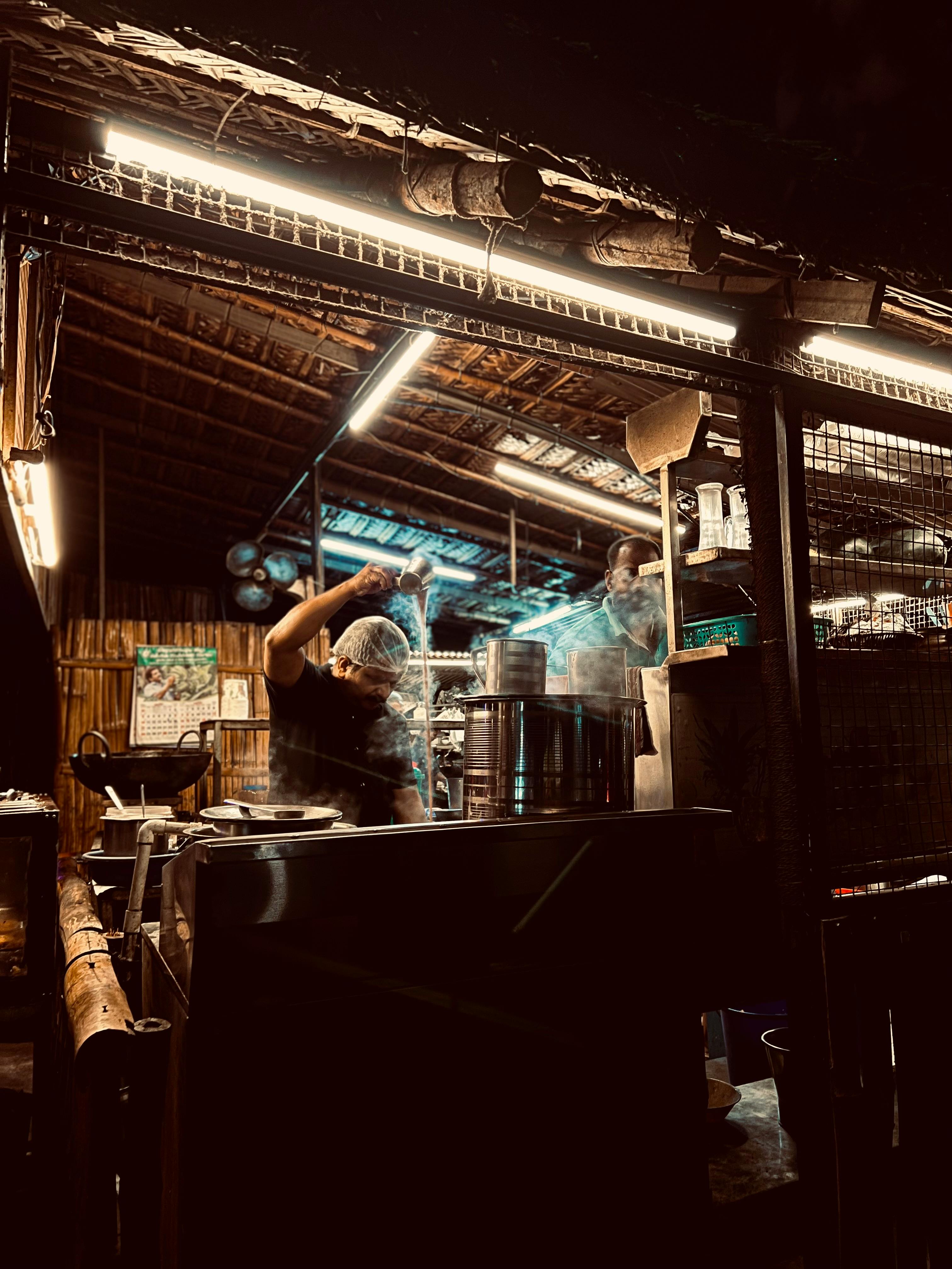 Man Working at Food Bar at Night · Free Stock Photo