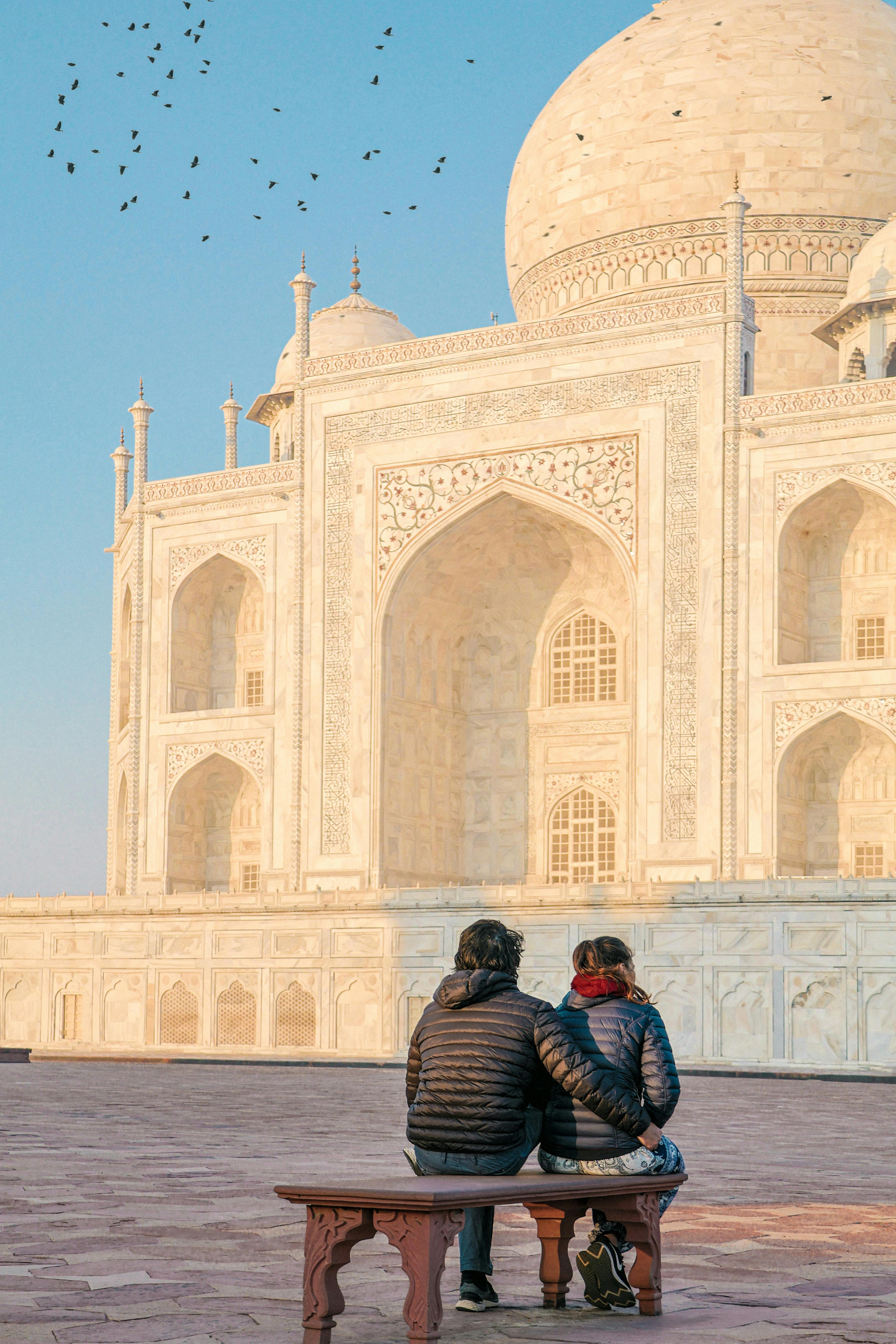 Couple Sitting on Bench by Taj Mahal · Free Stock Photo