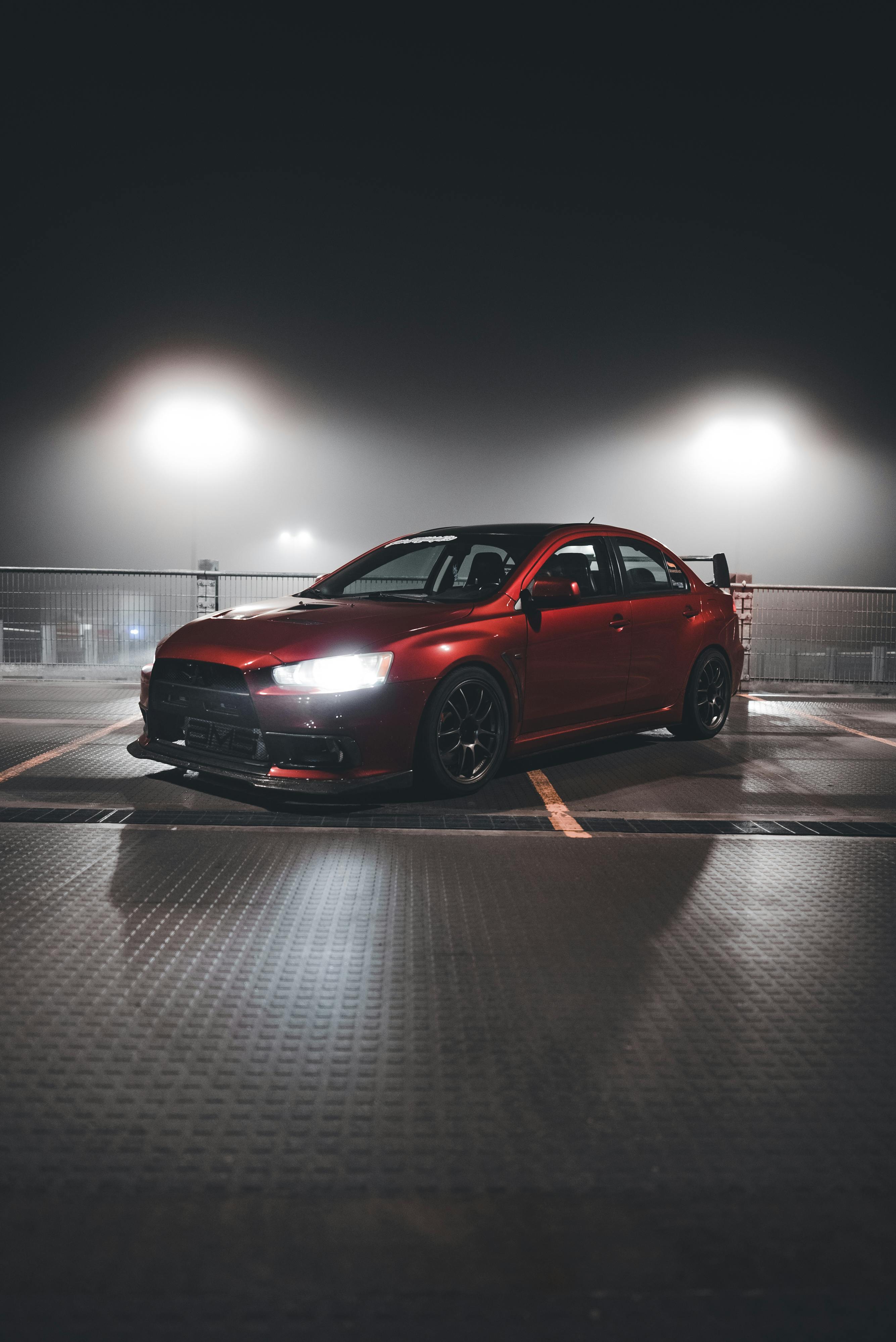 Red Mitsubishi Lancer Evolution at Night · Free Stock Photo