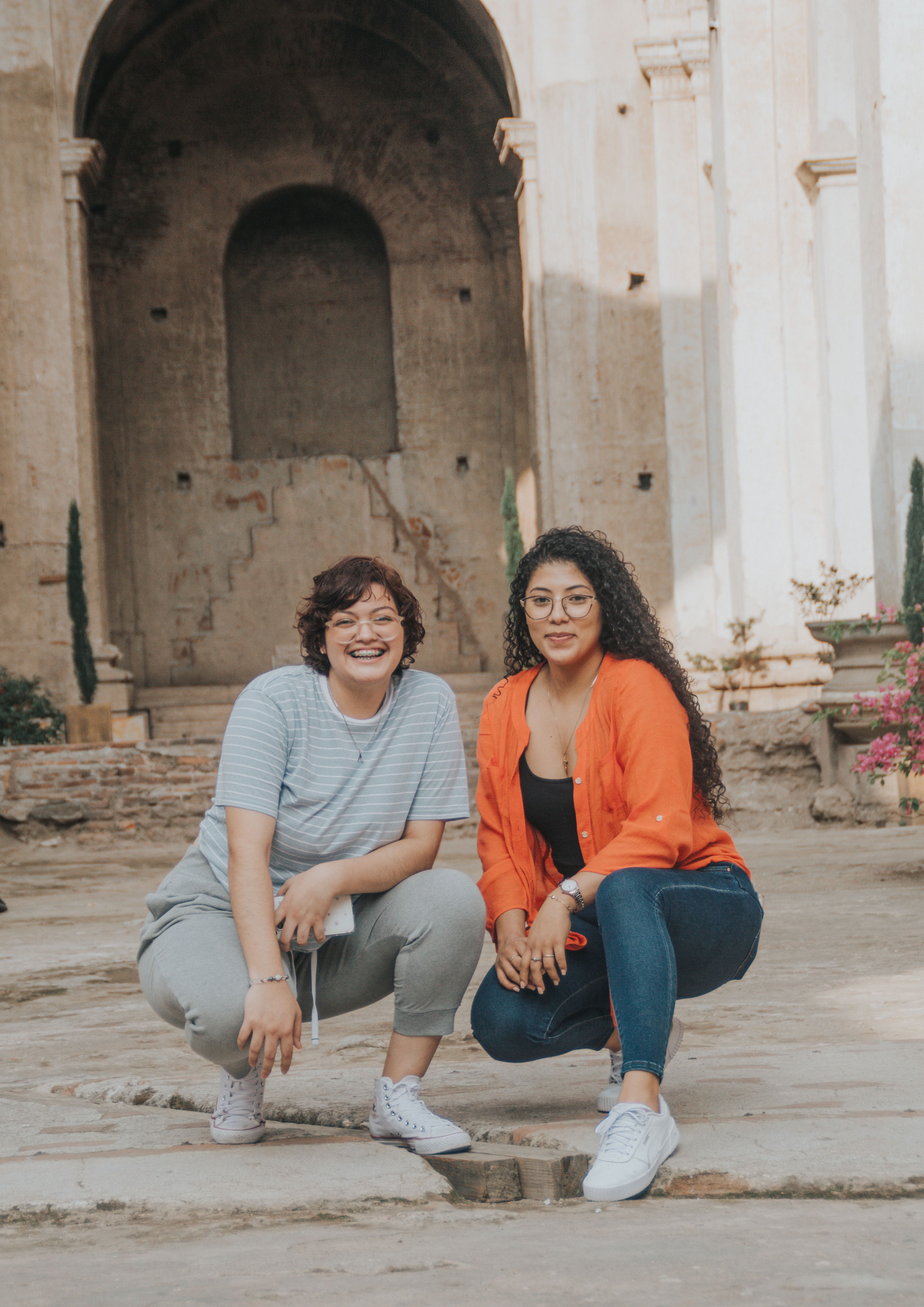 Young Women Crouching and Posing for a Photo · Free Stock Photo