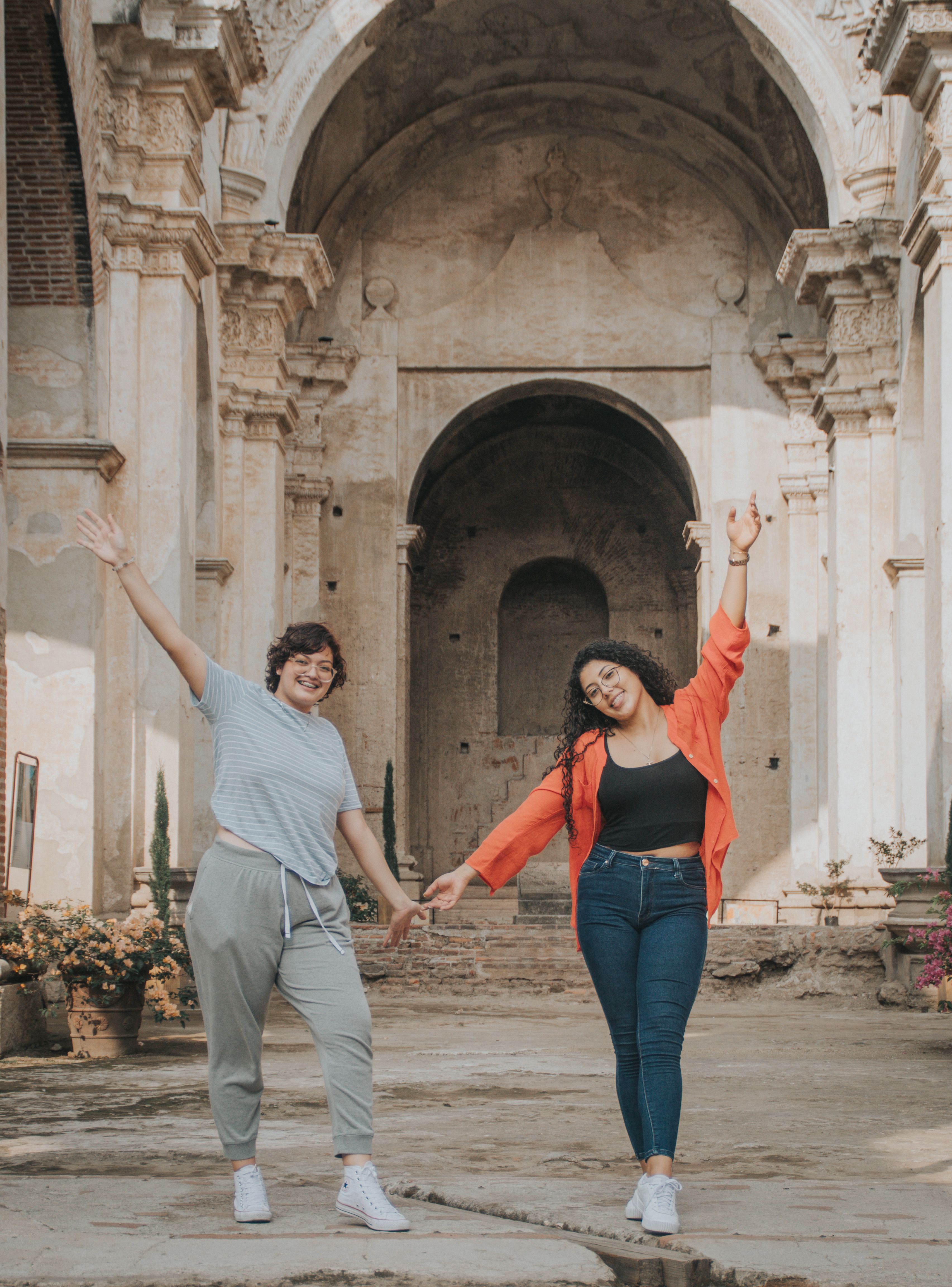 Young Women Holding Hands and Posing for a Photo · Free Stock Photo