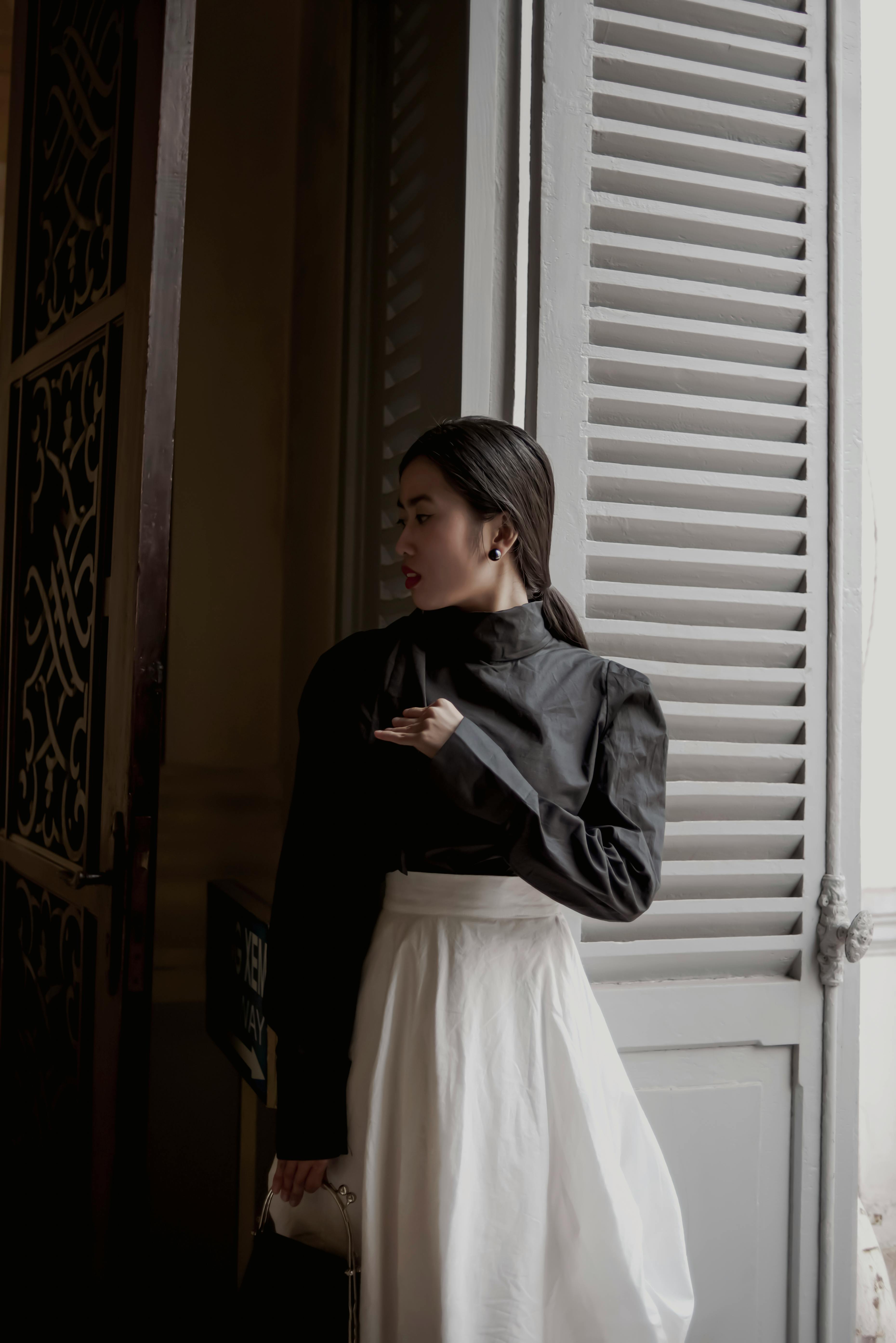 Woman Standing by White Window Shutter · Free Stock Photo