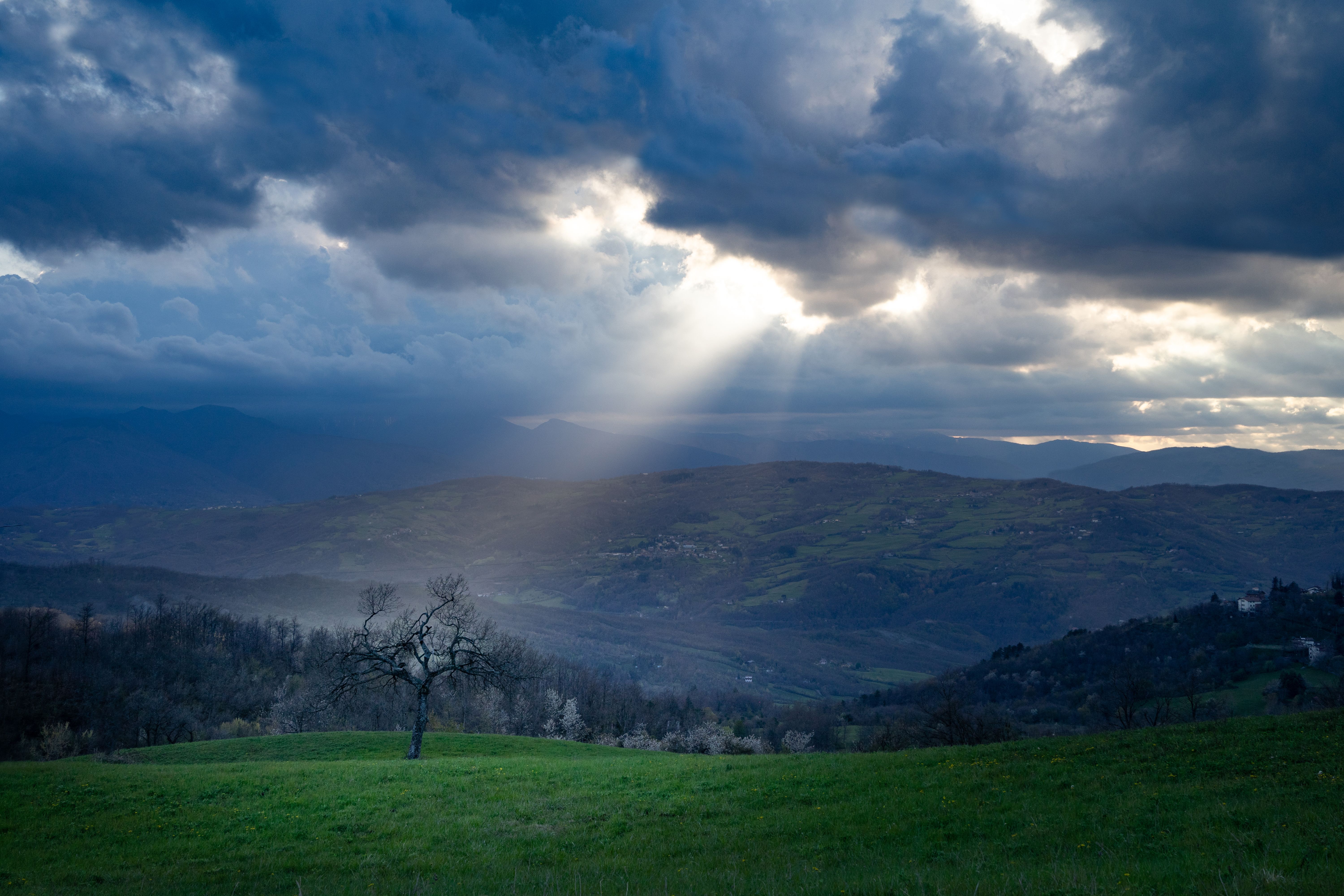 Sunbeams between Storm Clouds over Mountains · Free Stock Photo