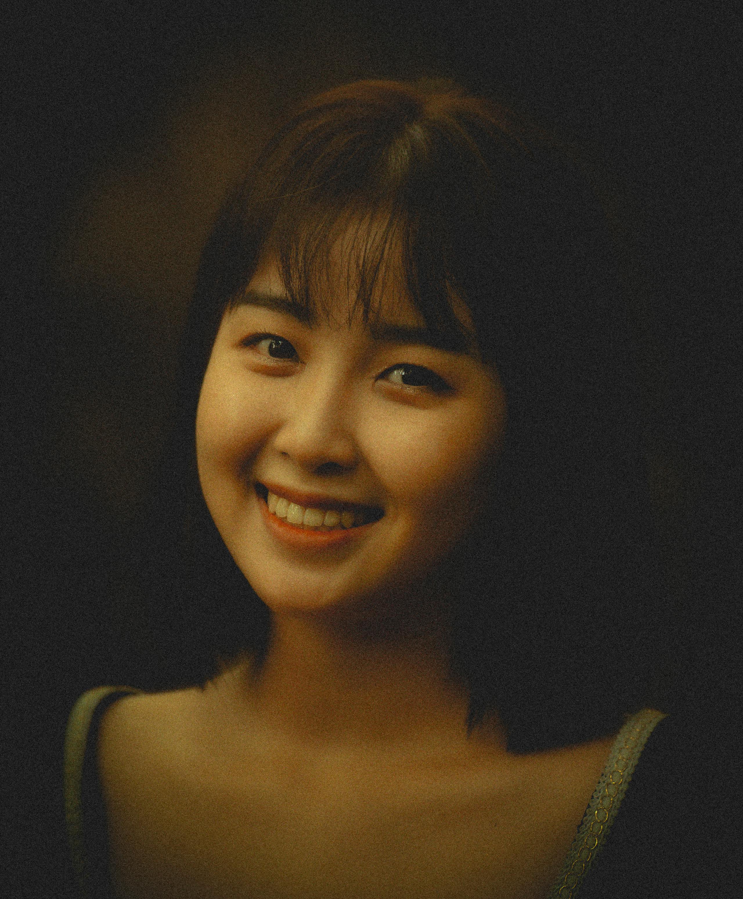 Portrait of a Young Brunette with Bangs Smiling · Free Stock Photo