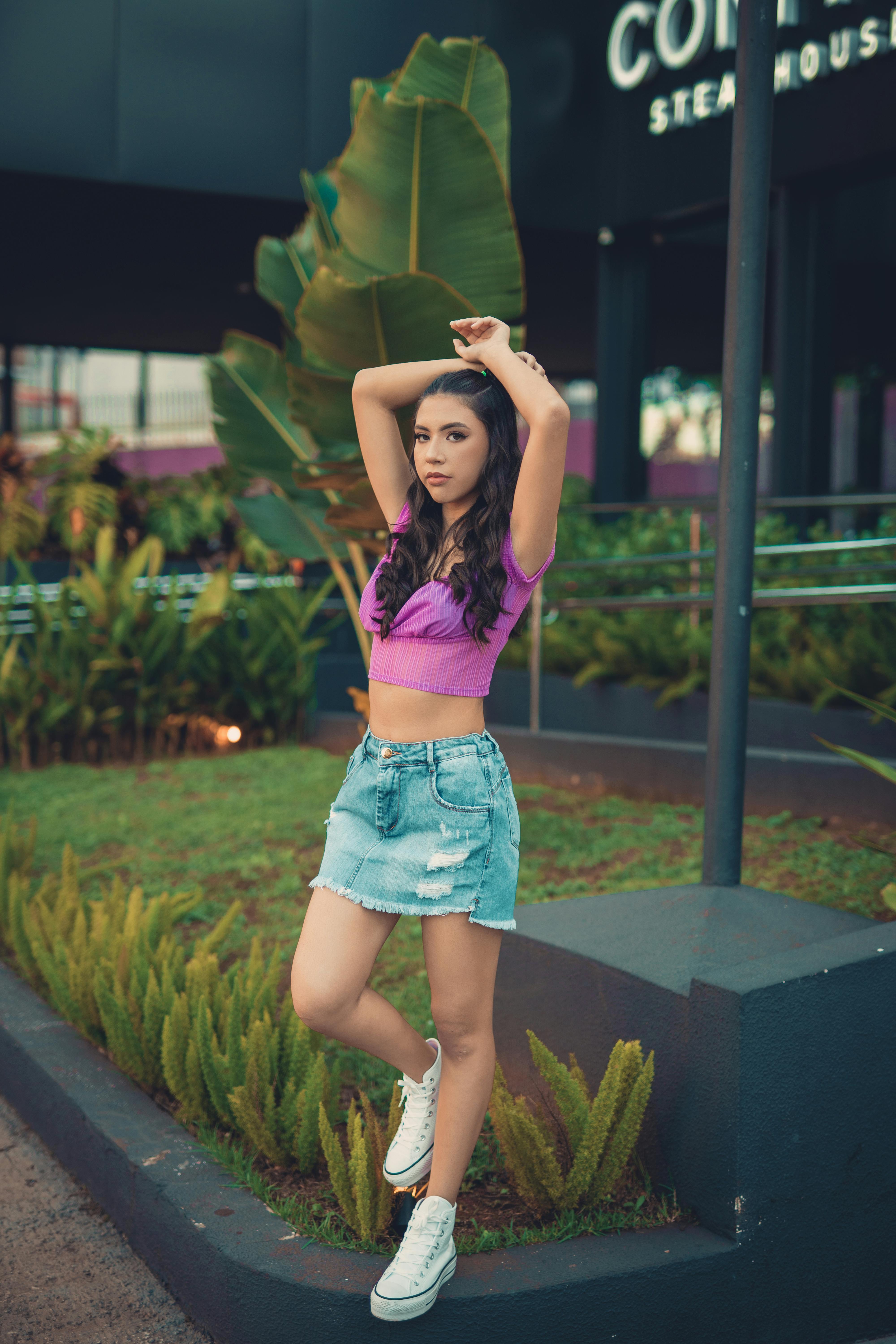 Woman Standing in Denim Skirt and Violet Tank Top · Free Stock Photo