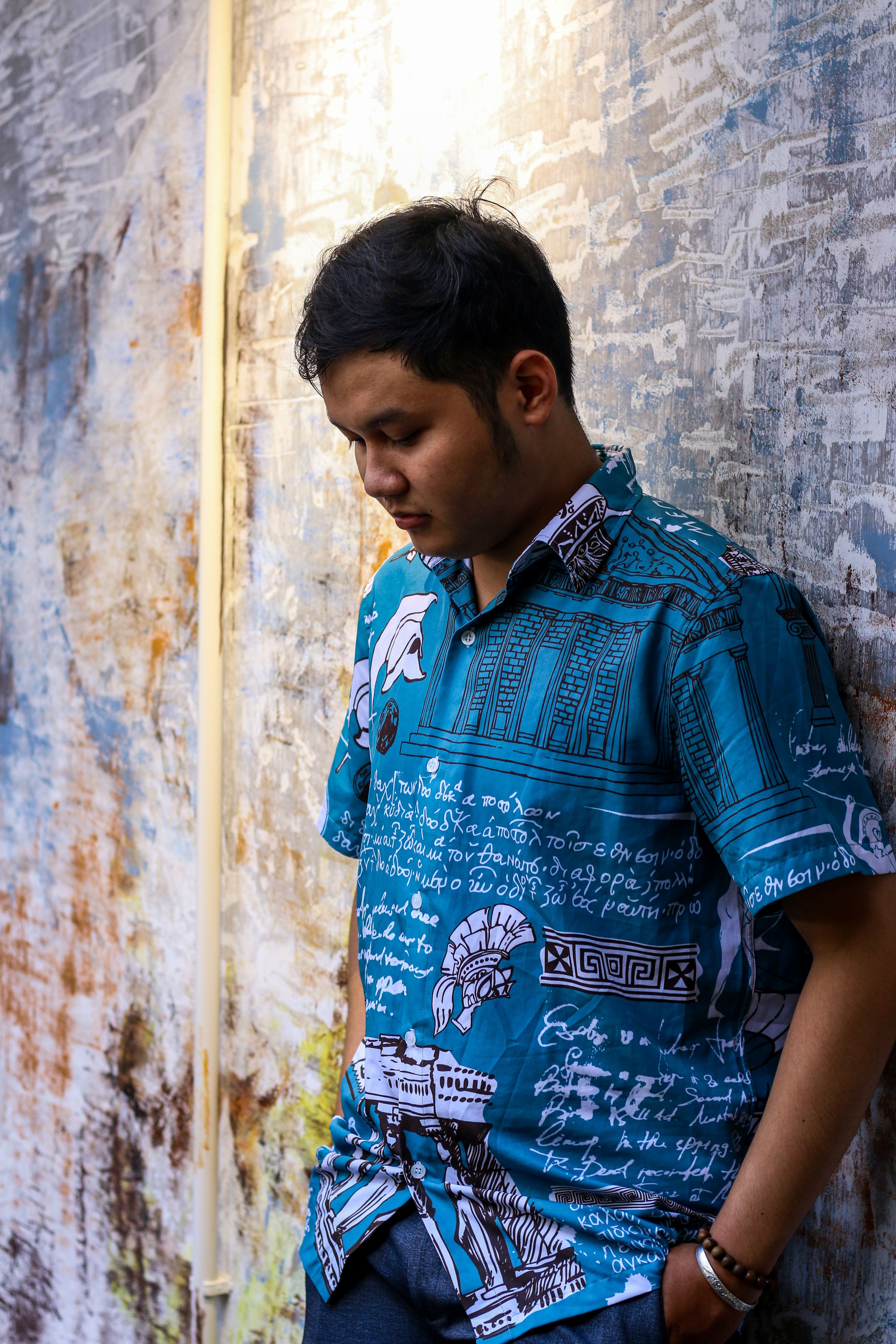 Portrait of a Young Man Looking Down while Leaning on a Wall · Free ...