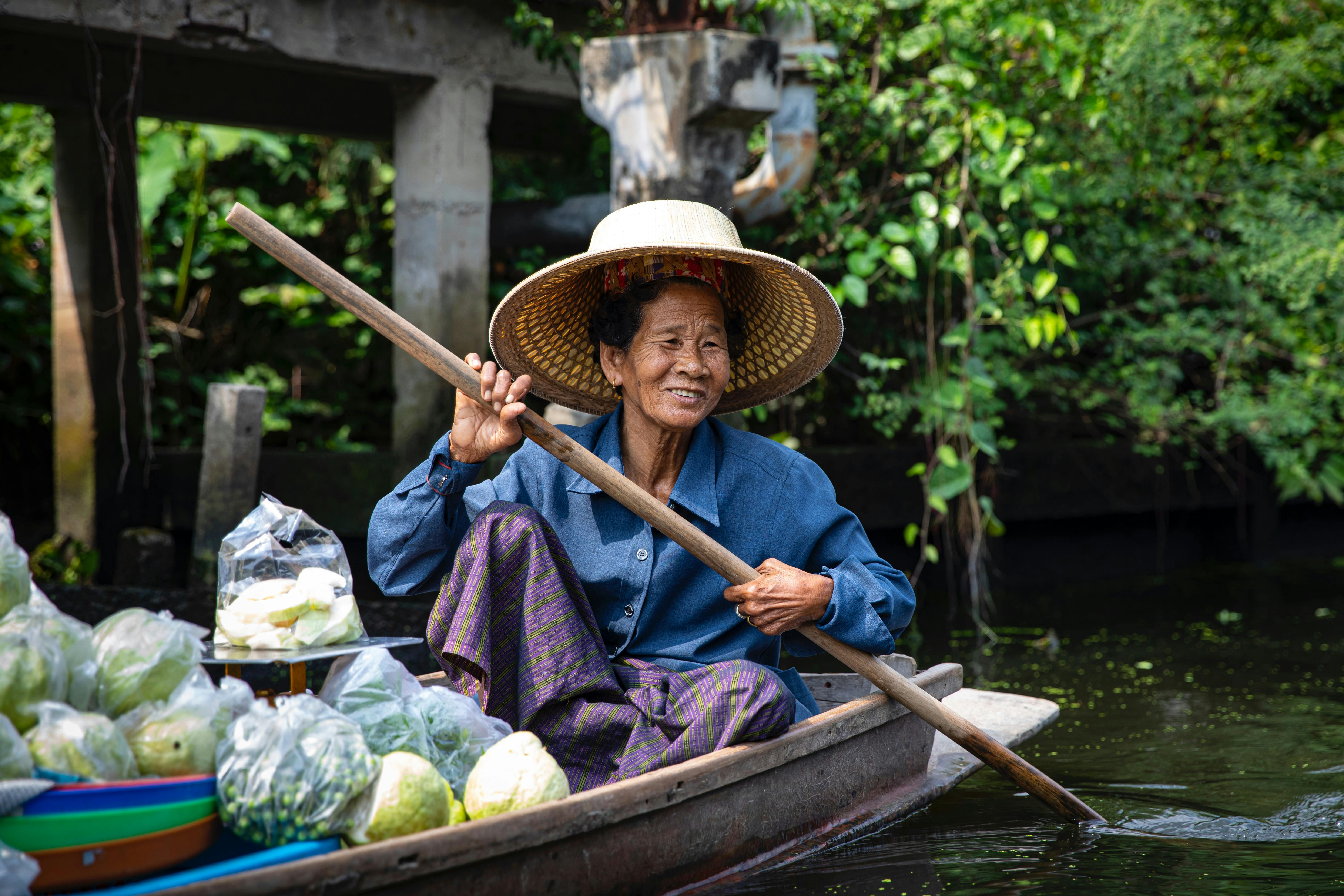 Man Rowing a Boat and Transporting Vegetables · Free Stock Photo