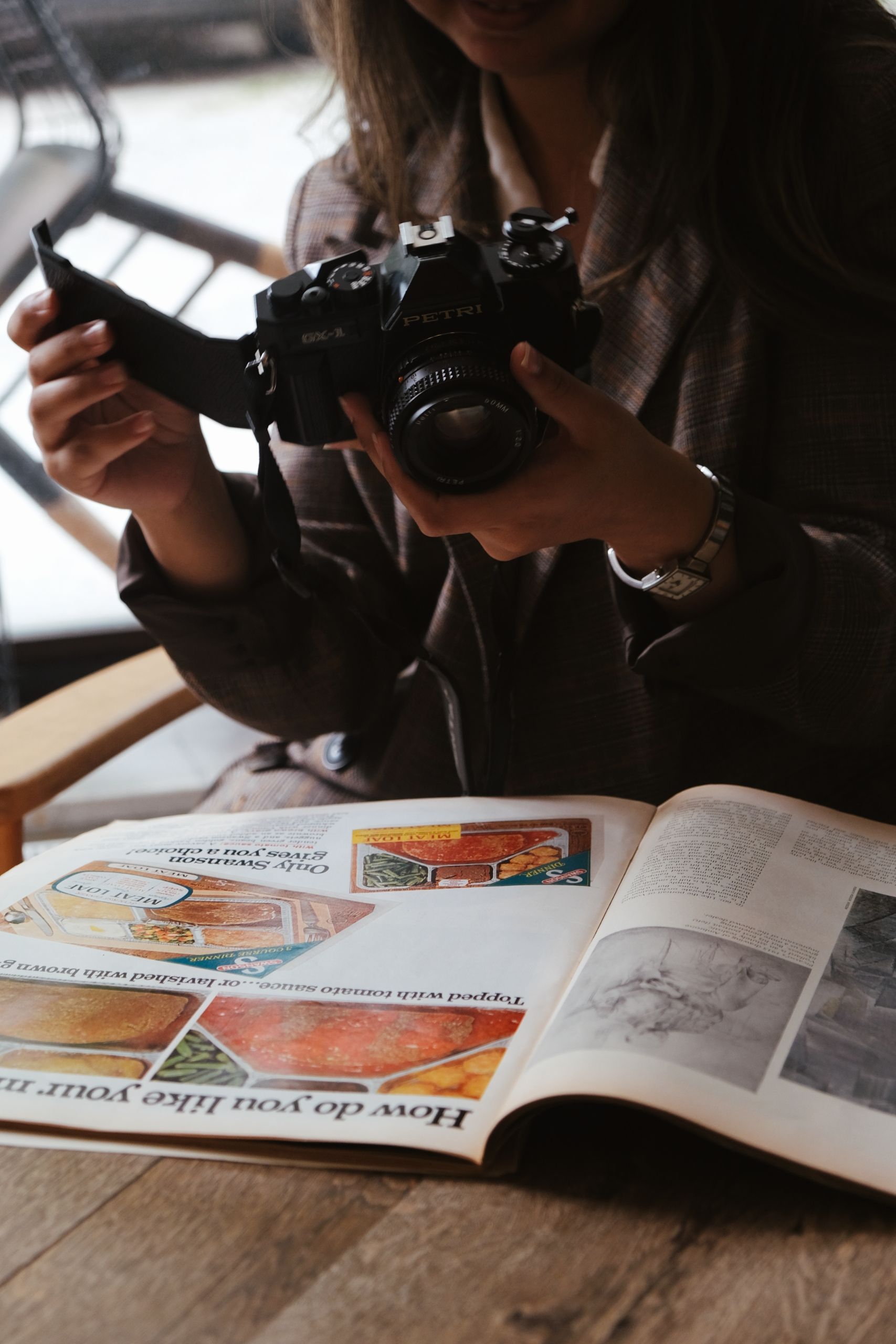 Camera Lying on a Newspaper · Free Stock Photo