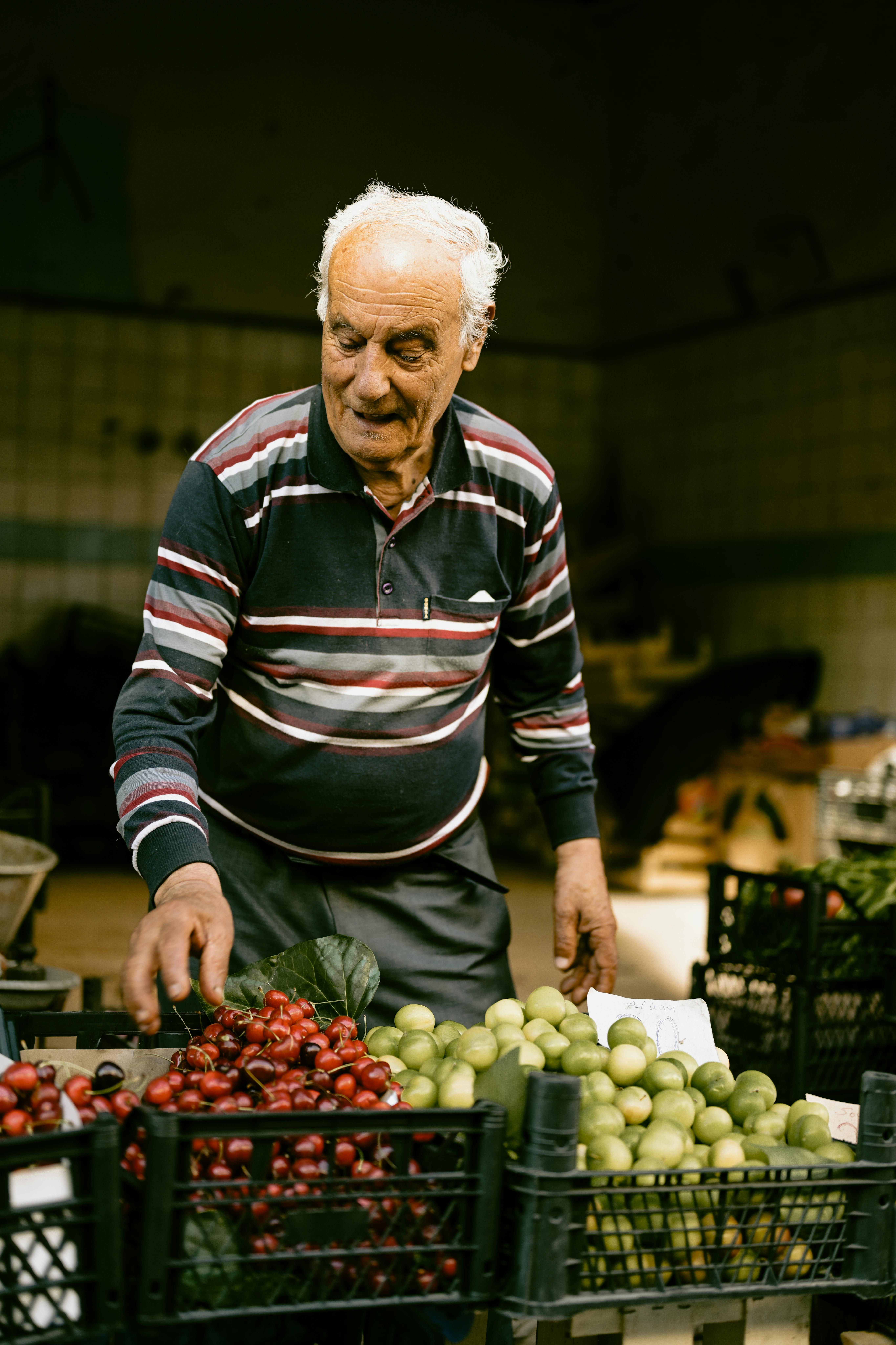 Man Selling Fresh Fruit at a Market · Free Stock Photo
