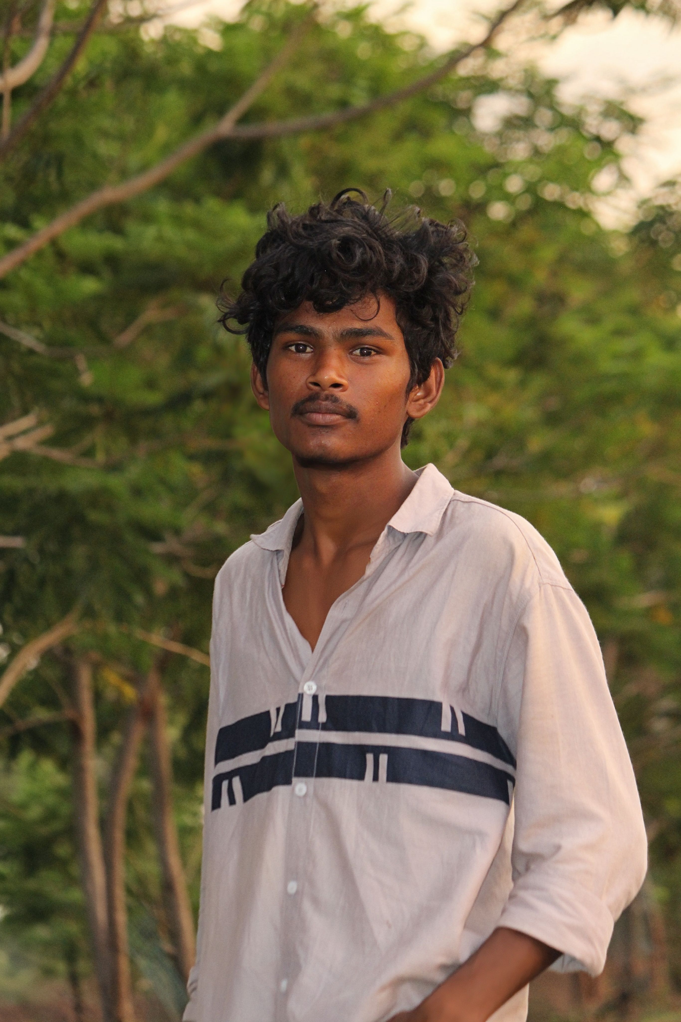 Photo of a Young Indian Boy Wearing a Blue Plaid Shirt · Free Stock Photo