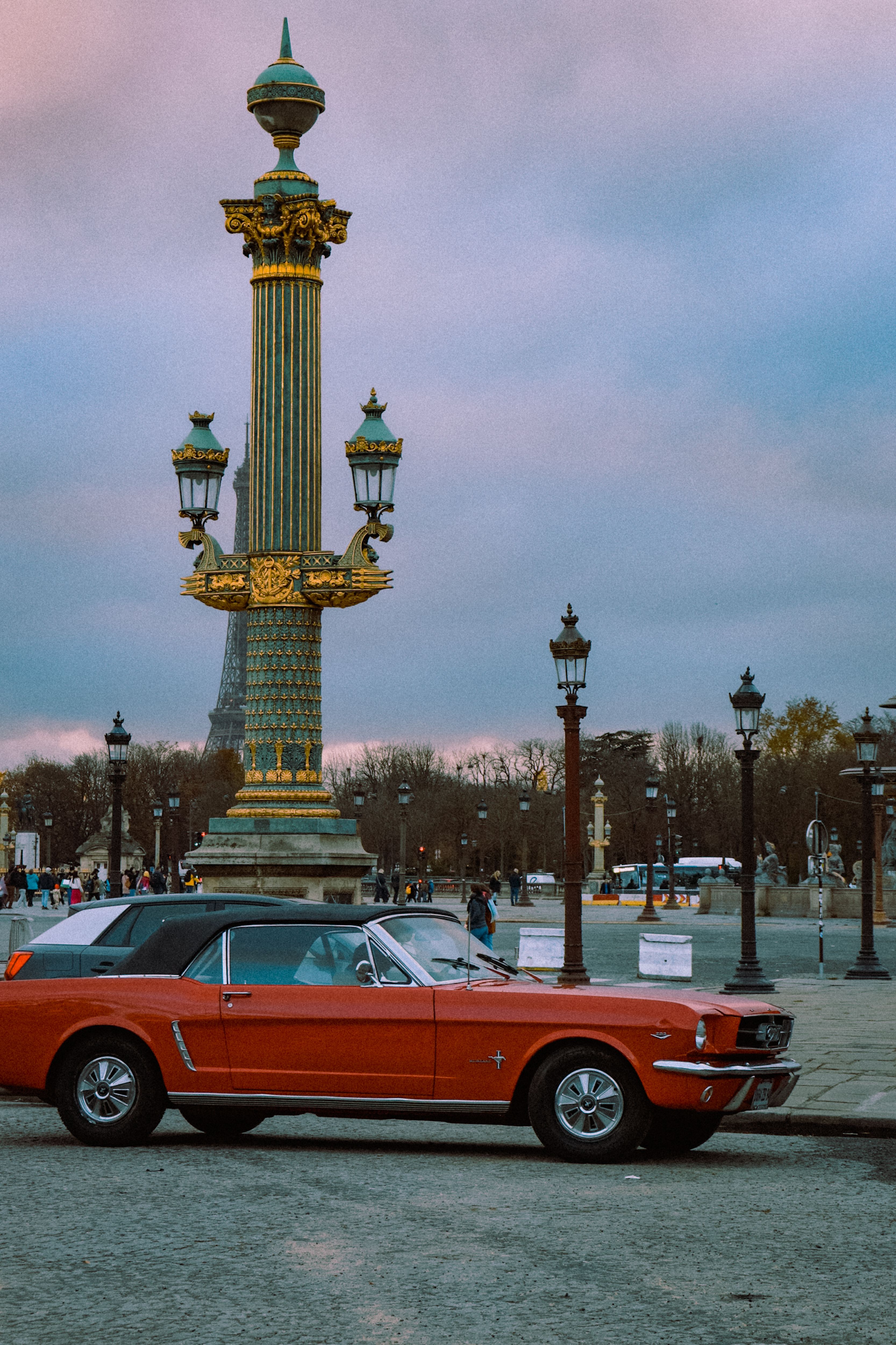 A vintage car parked in front of a monument · Free Stock Photo
