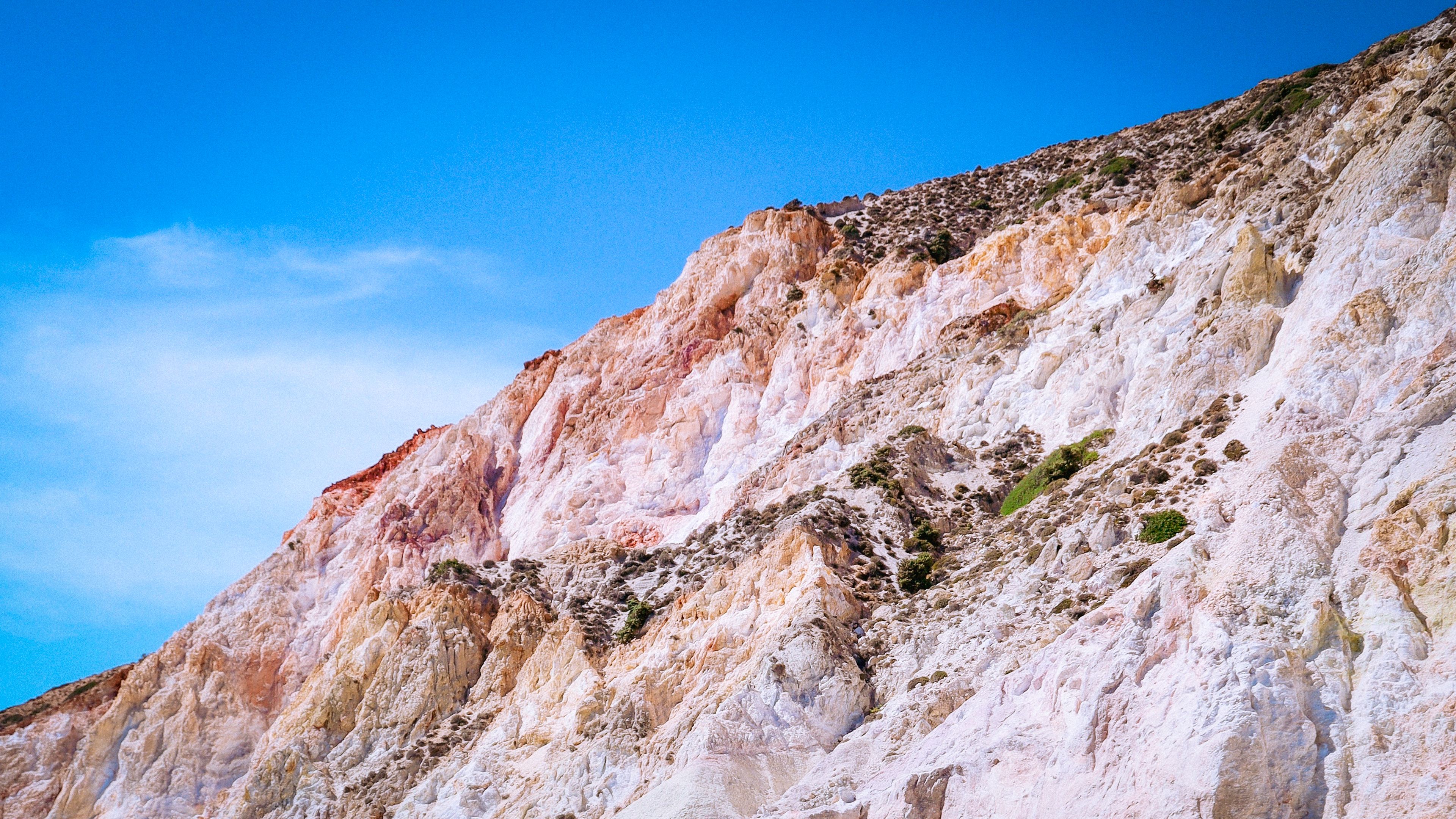 A person standing on the side of a cliff · Free Stock Photo