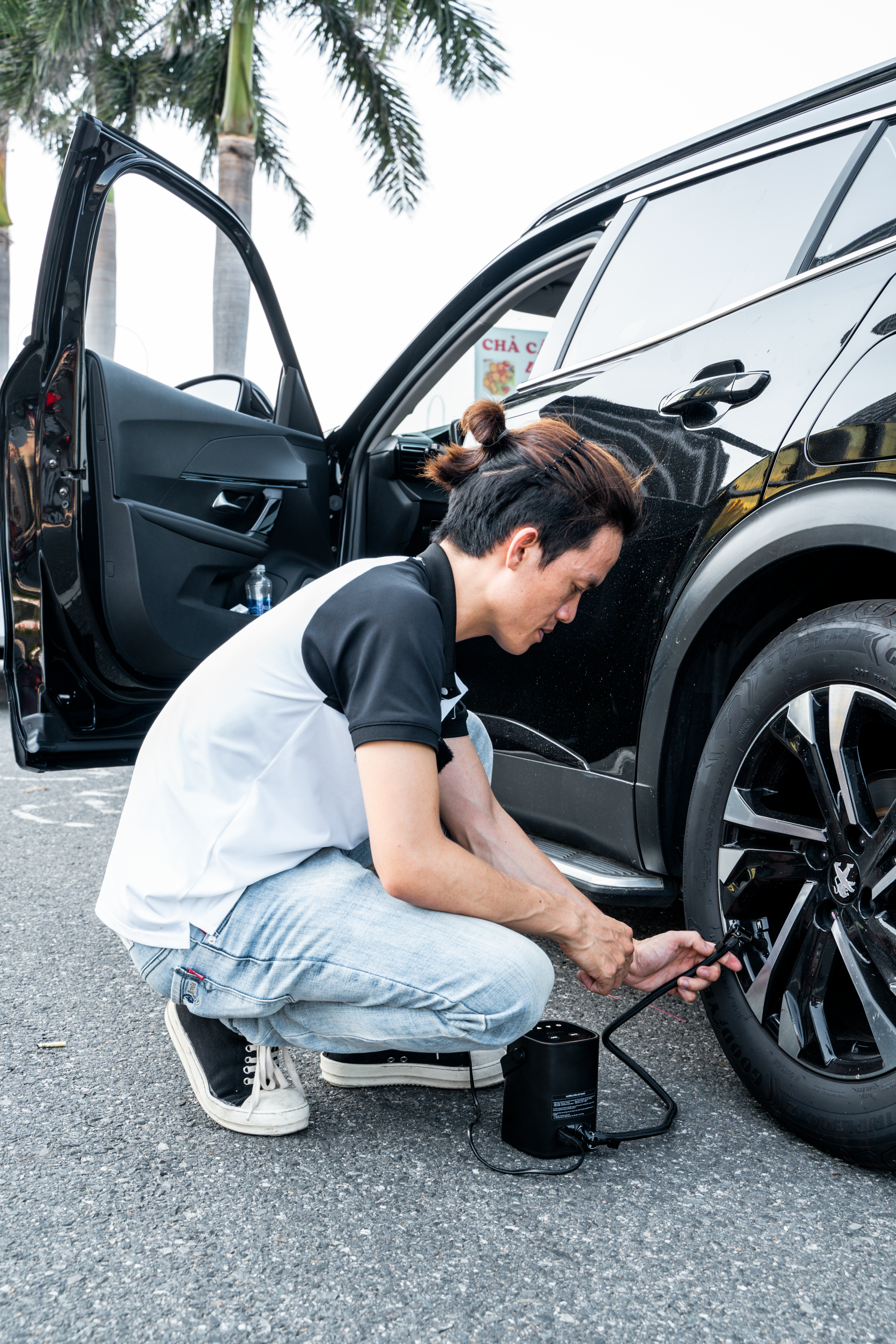 Man Inflating Car Tire · Free Stock Photo