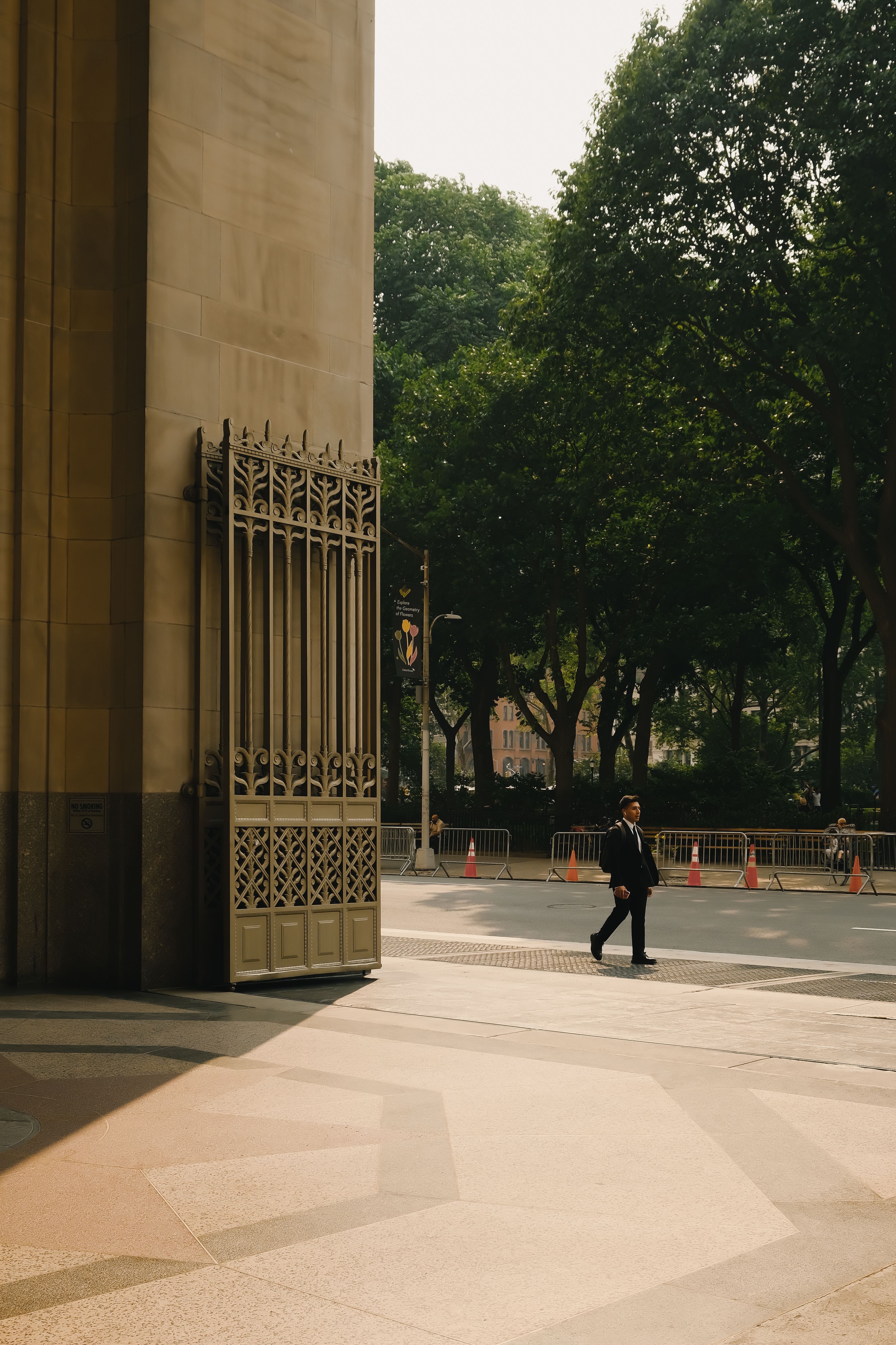 Man Walking near Gate on Building Wall · Free Stock Photo