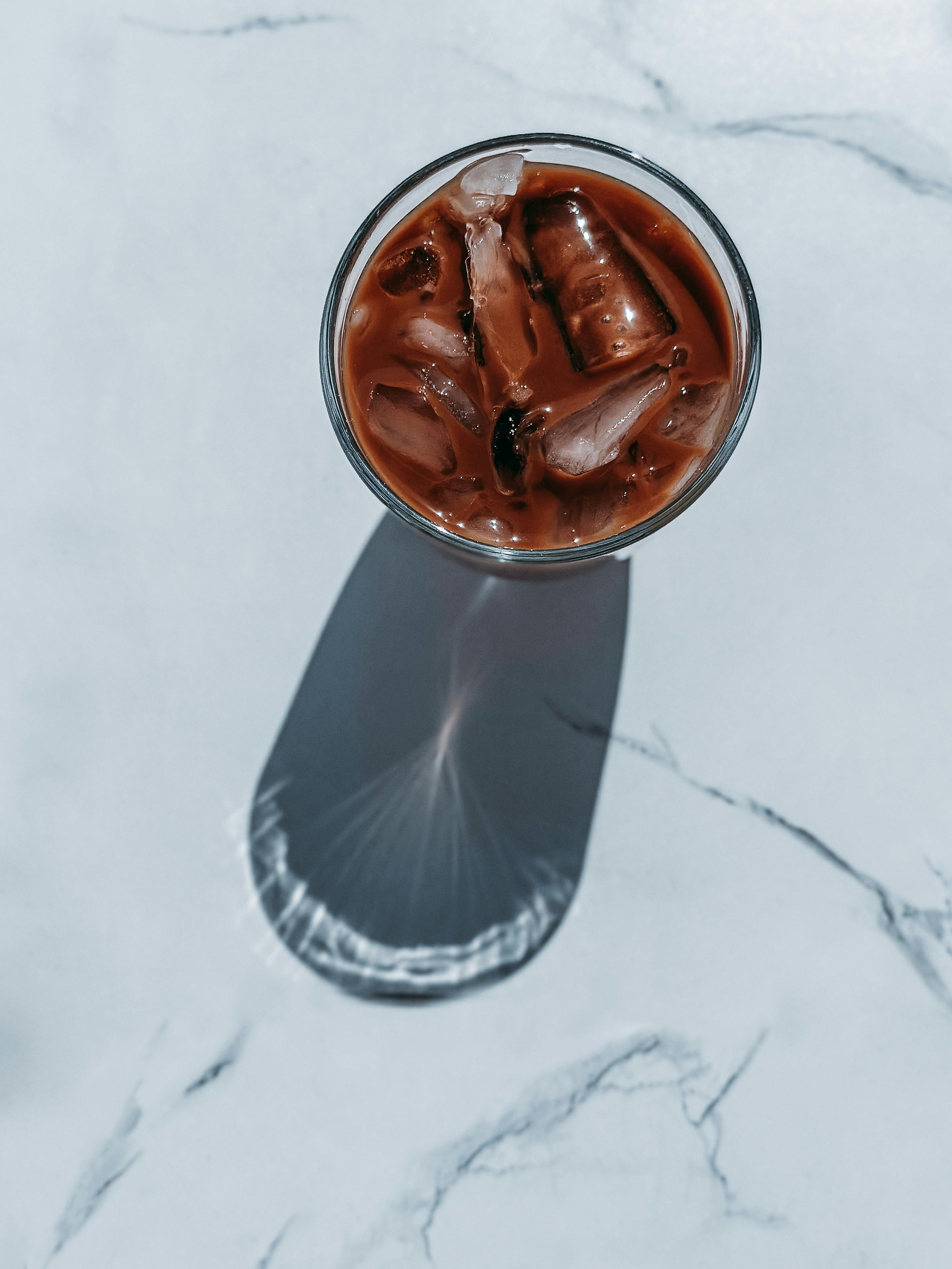 A Glass of Ice Coffee on a Wooden Table · Free Stock Photo