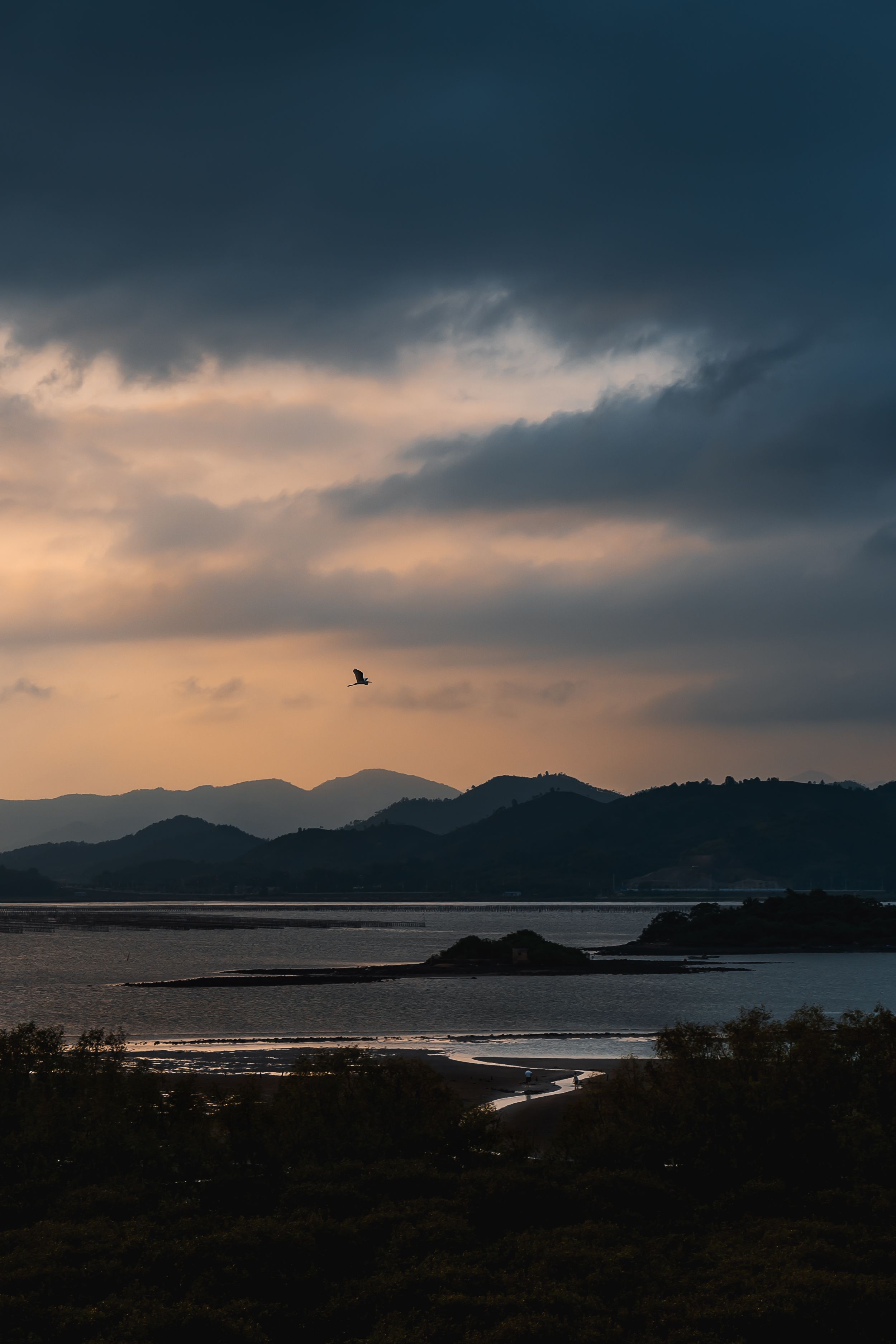Rain Clouds over Sea Shore with Town behind · Free Stock Photo