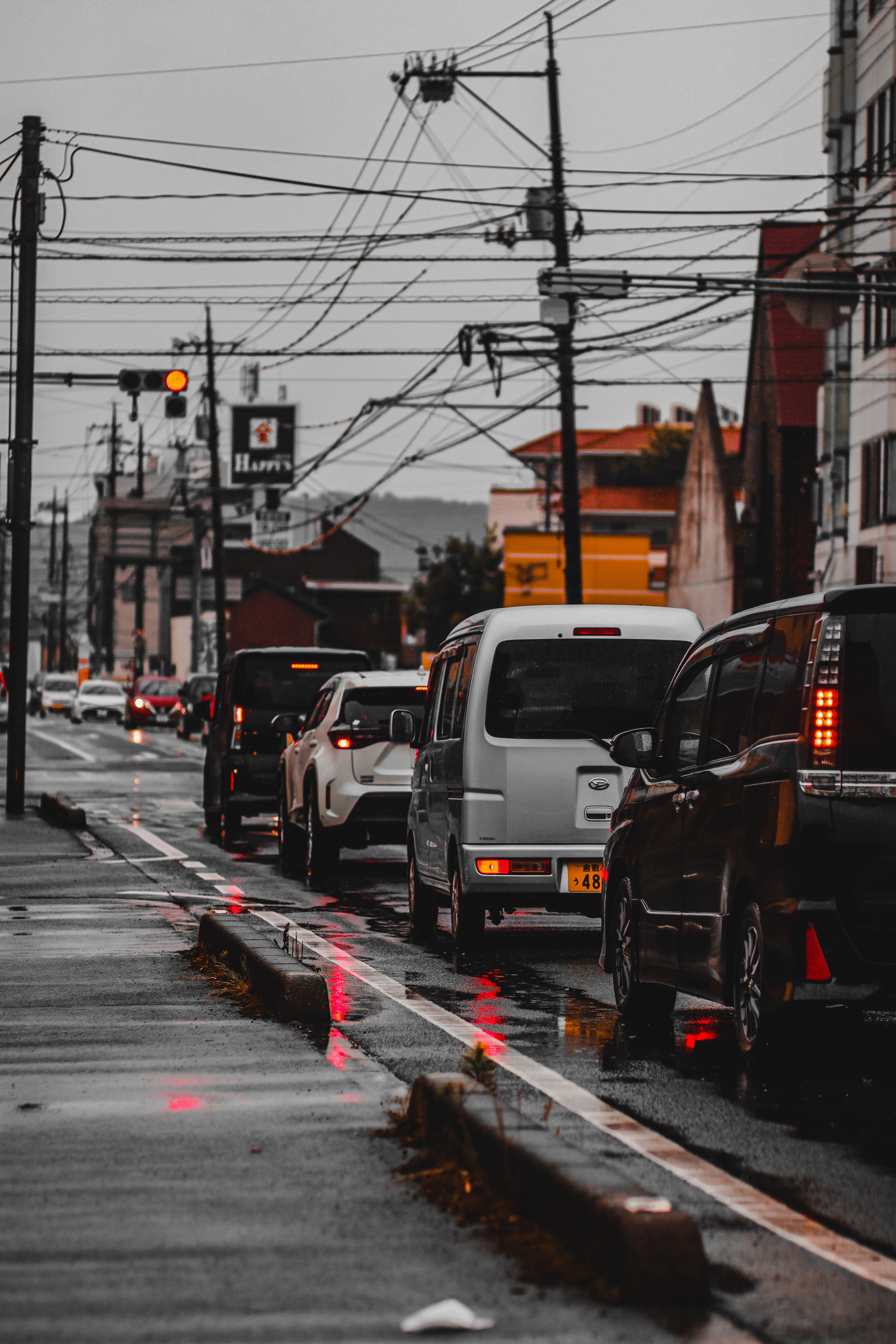 Cars Waiting at a Street Intersection on a Rainy Day · Free Stock Photo