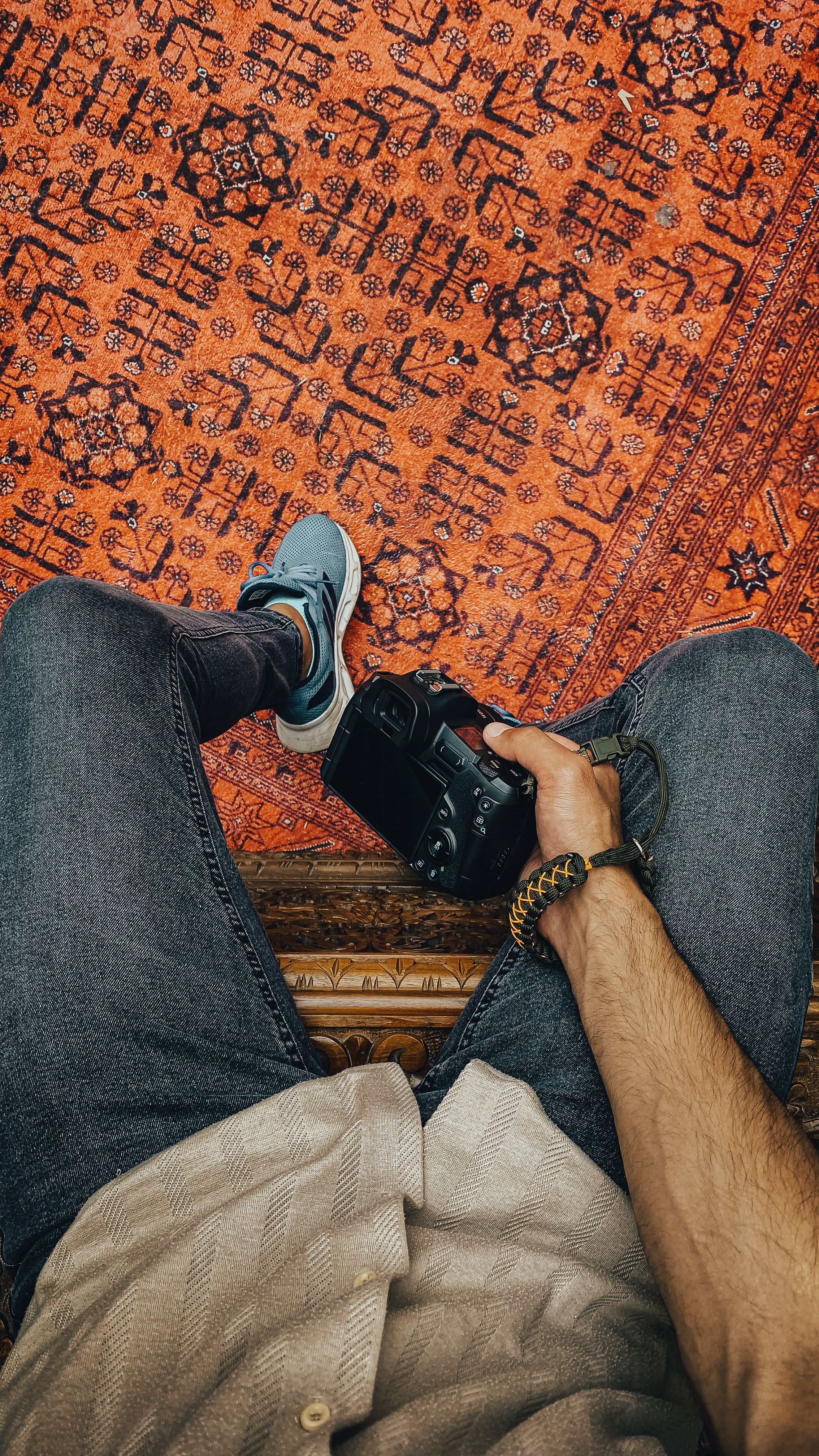 Man Holding Leg on Ornate Floor · Free Stock Photo