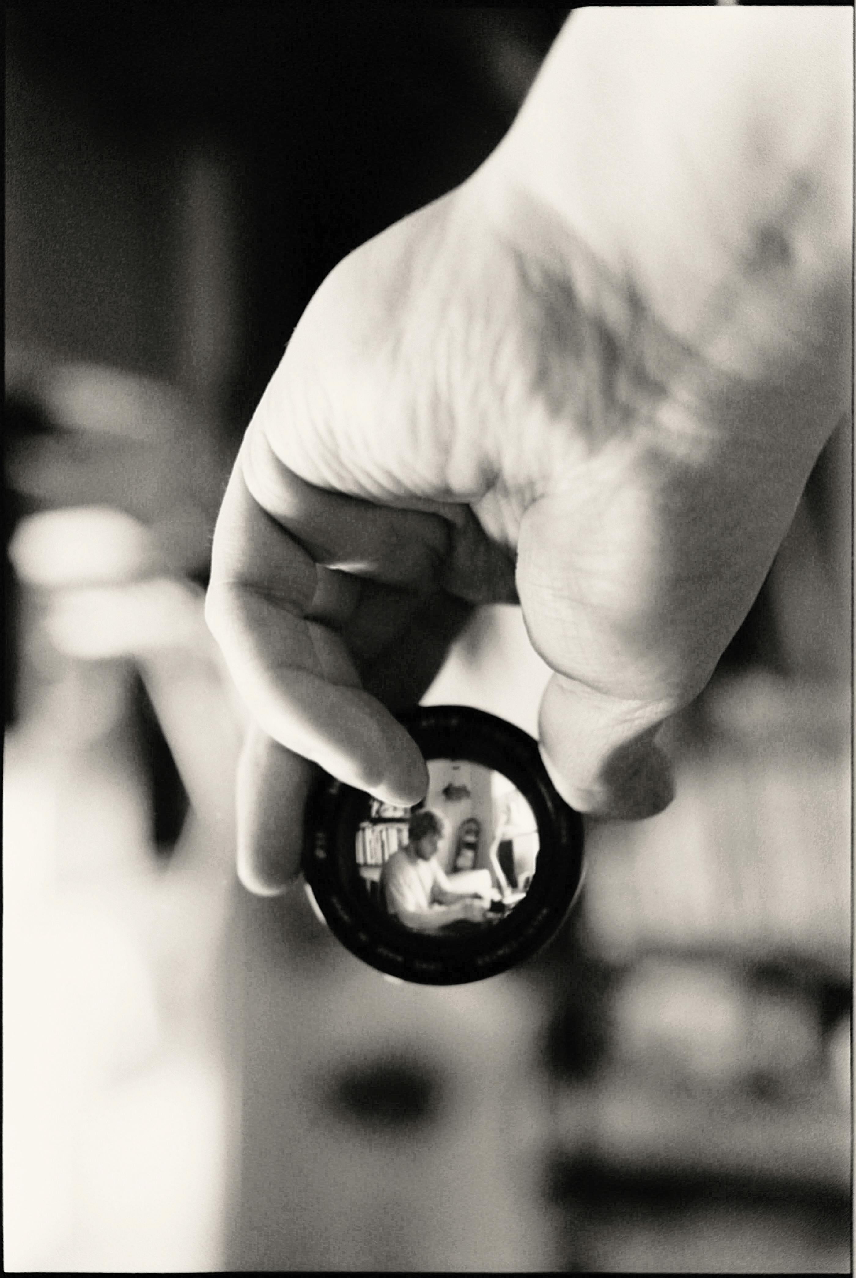 Hand Holding Lens in Black and White · Free Stock Photo