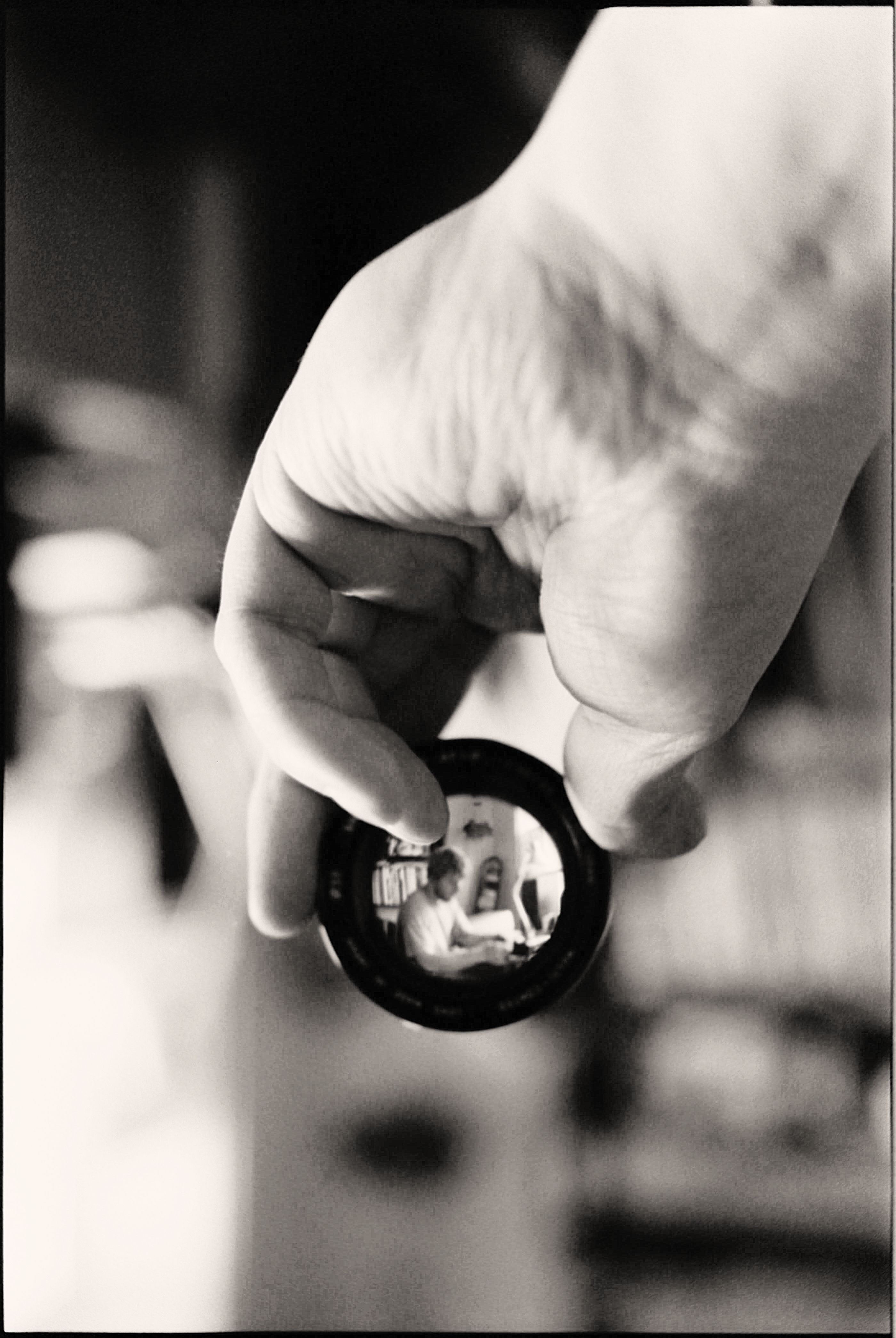 Hand Holding Lens in Black and White · Free Stock Photo