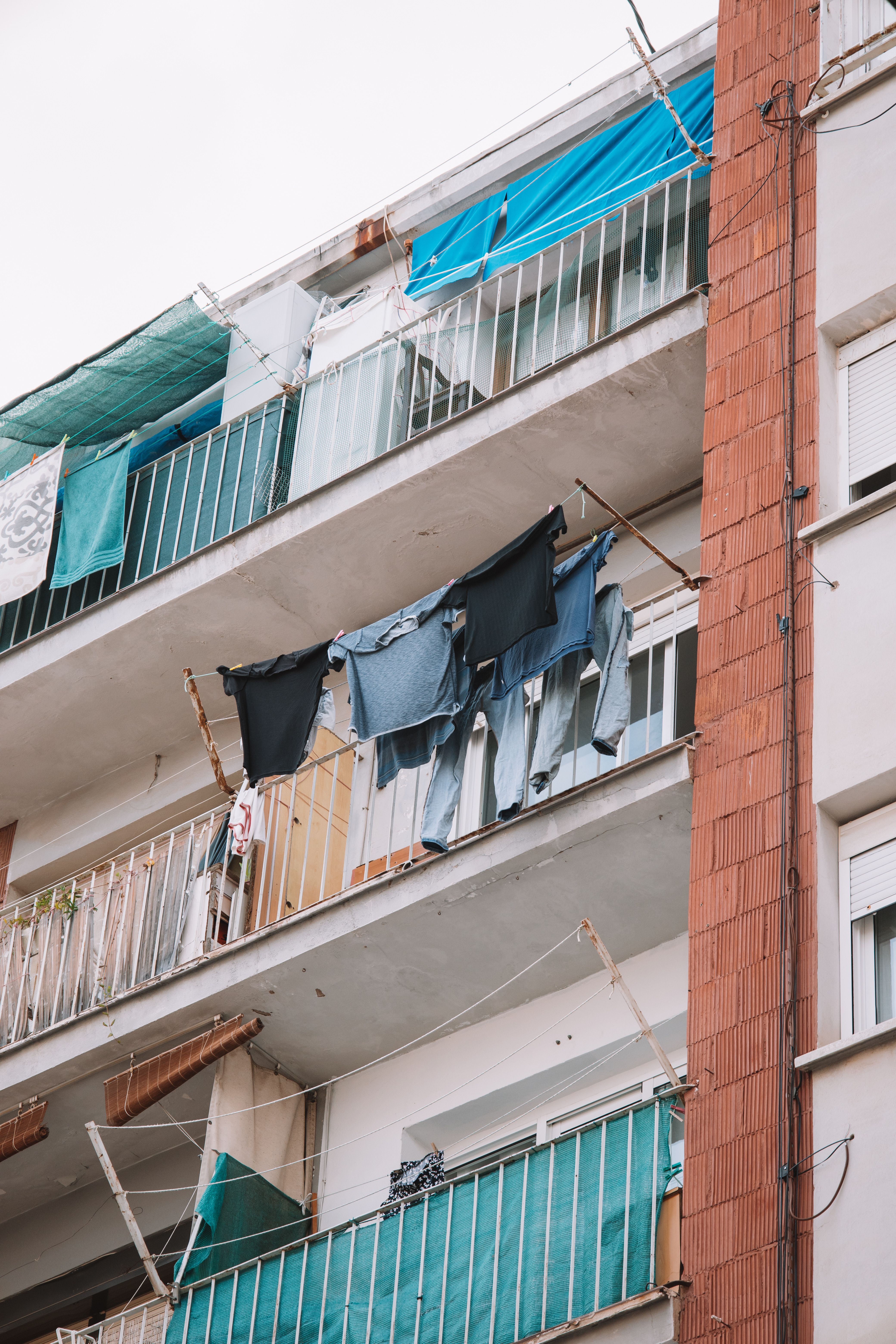 Laundry Drying on Balconies of Apartment Building · Free Stock Photo