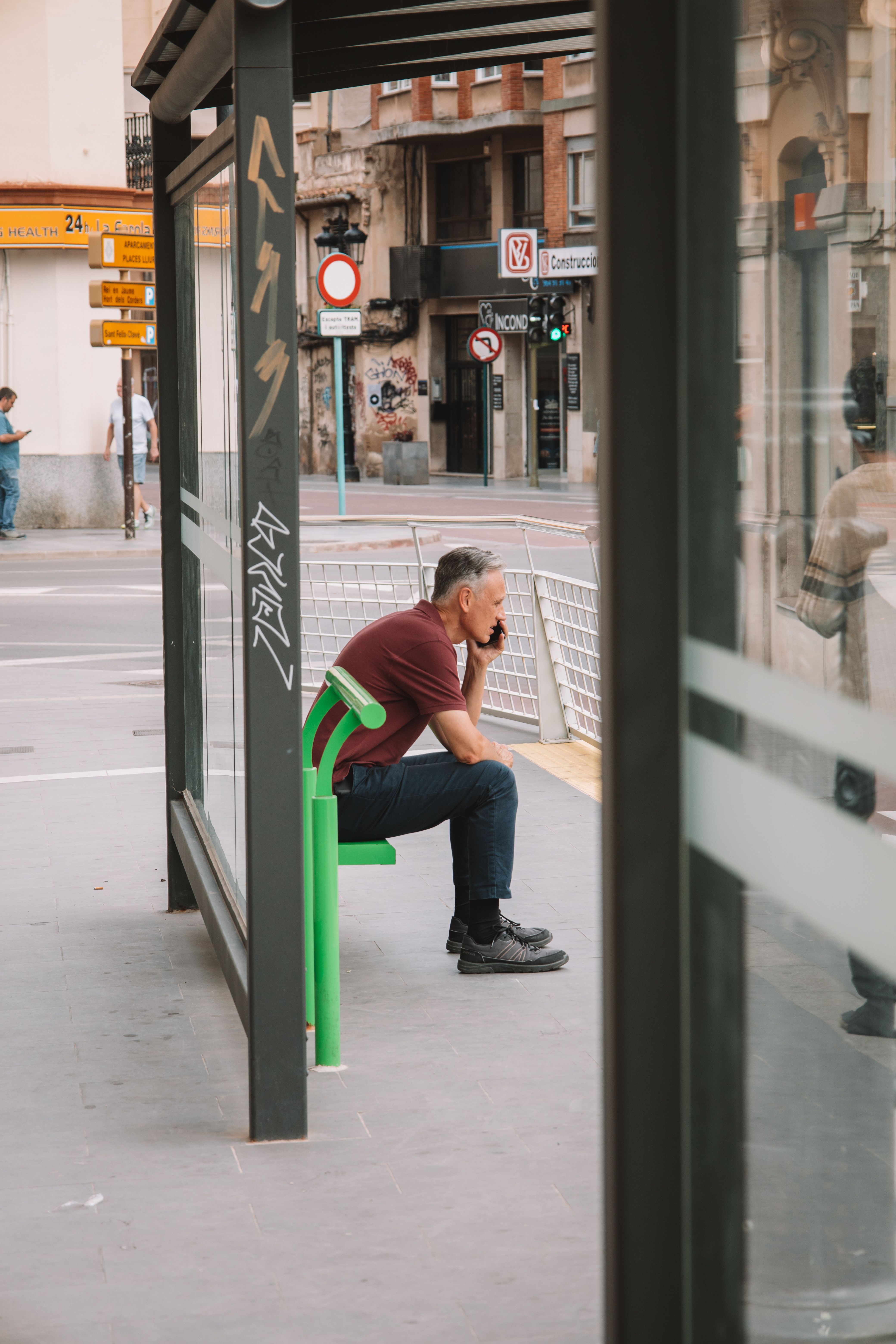 Man Waiting on a Bus Stop · Free Stock Photo