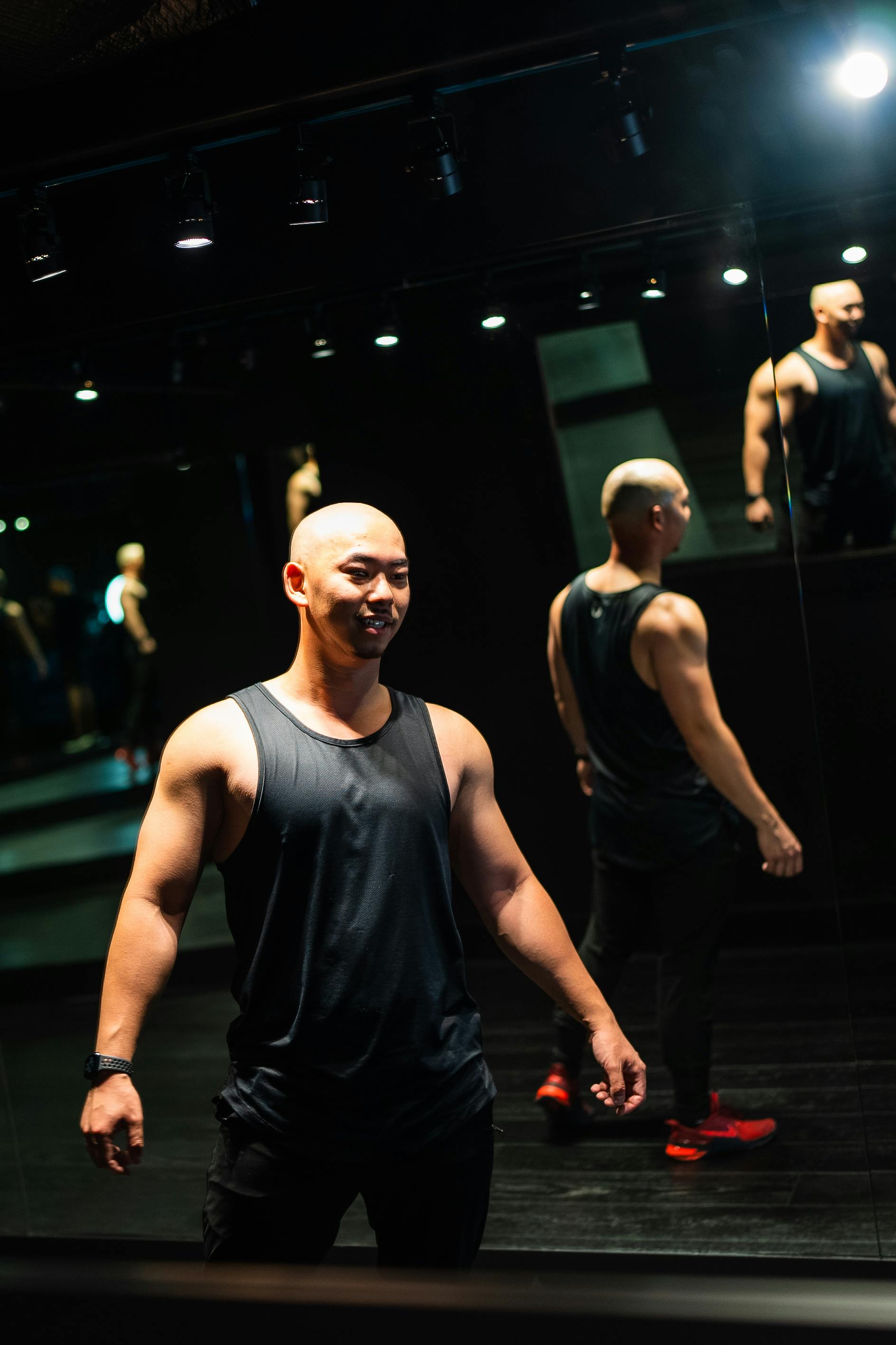 A Muscular Man Reflecting in Mirrors · Free Stock Photo