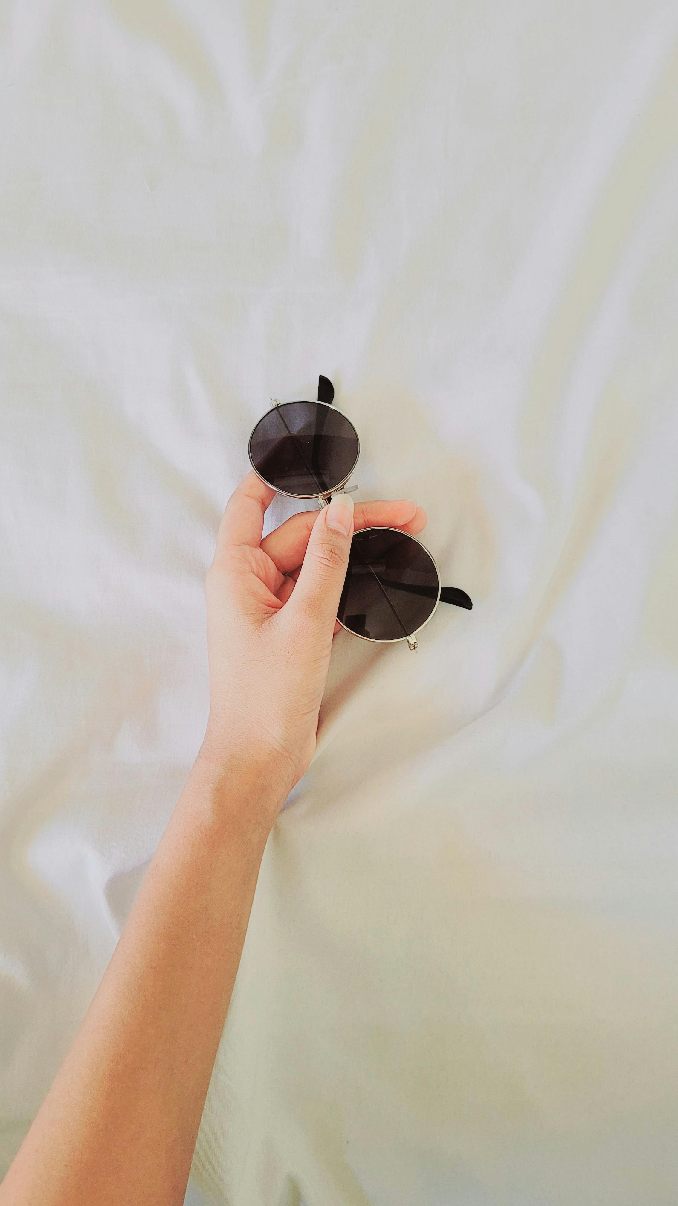 Woman Hand Holding Sunglasses · Free Stock Photo