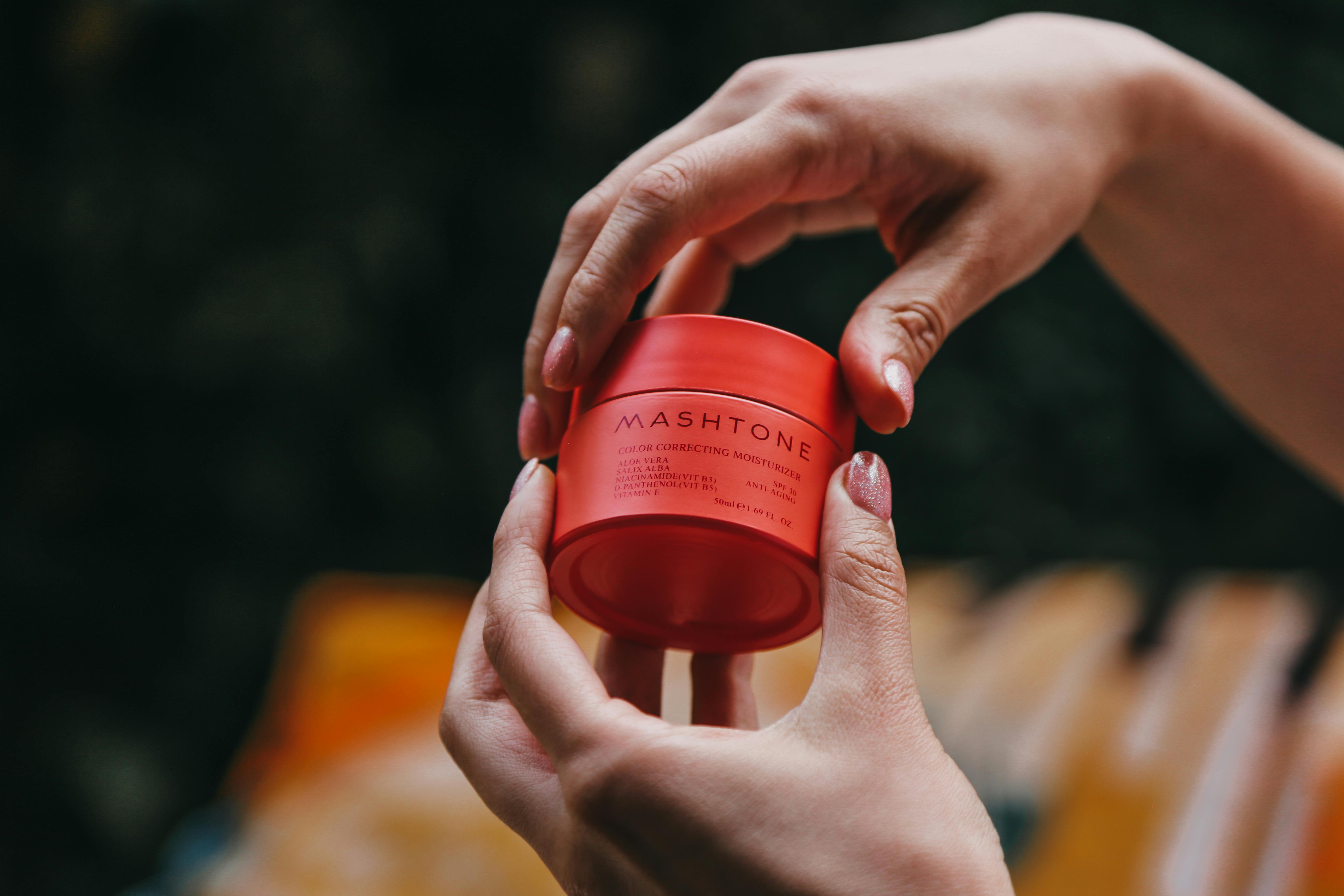 Woman Opening a Jar of Moisturizer · Free Stock Photo