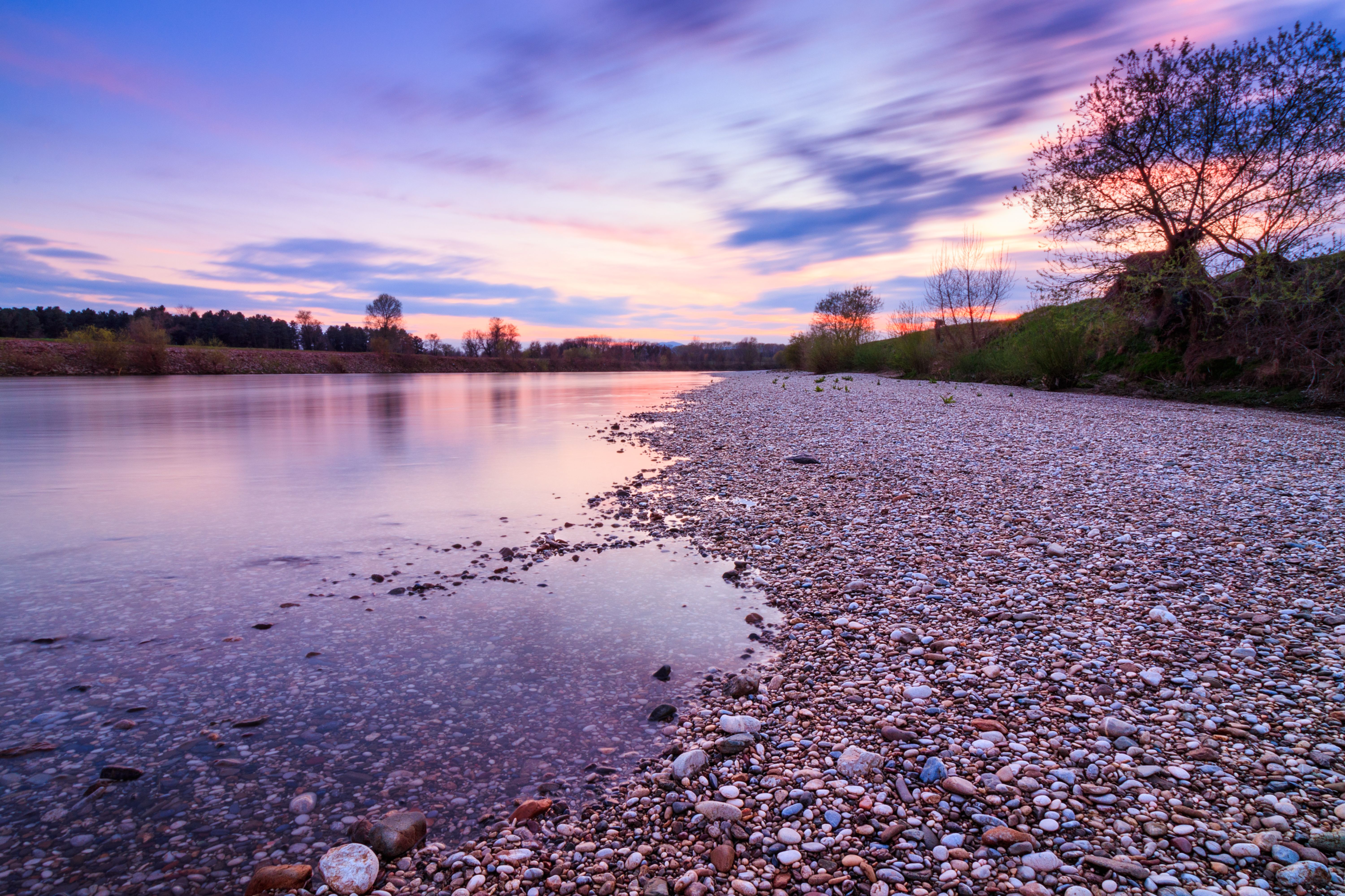 River and Pebbles on the River Bank under a Dramatic Sky at Dusk · Free ...