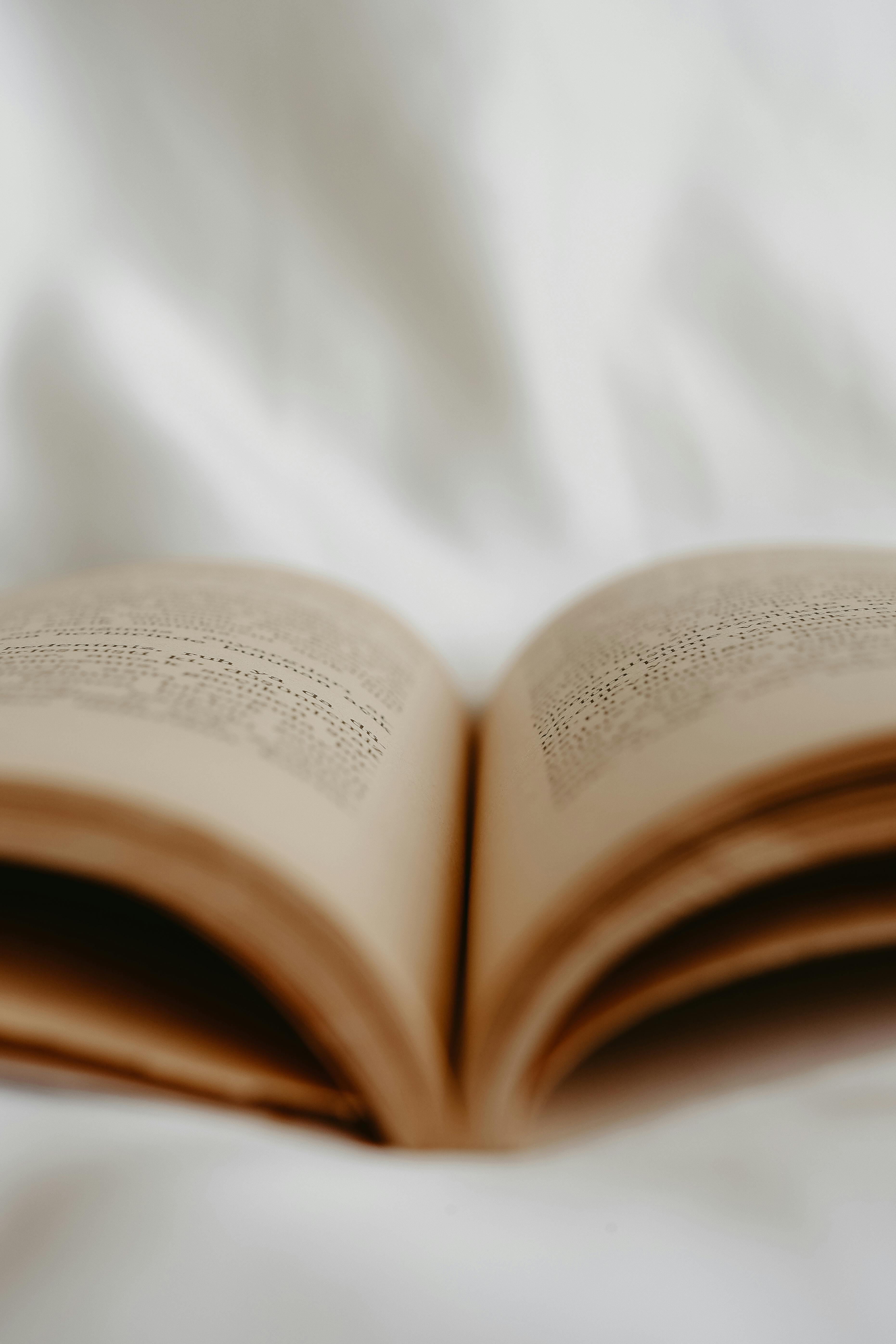 Close-up of an Open Book on a White Sheet · Free Stock Photo