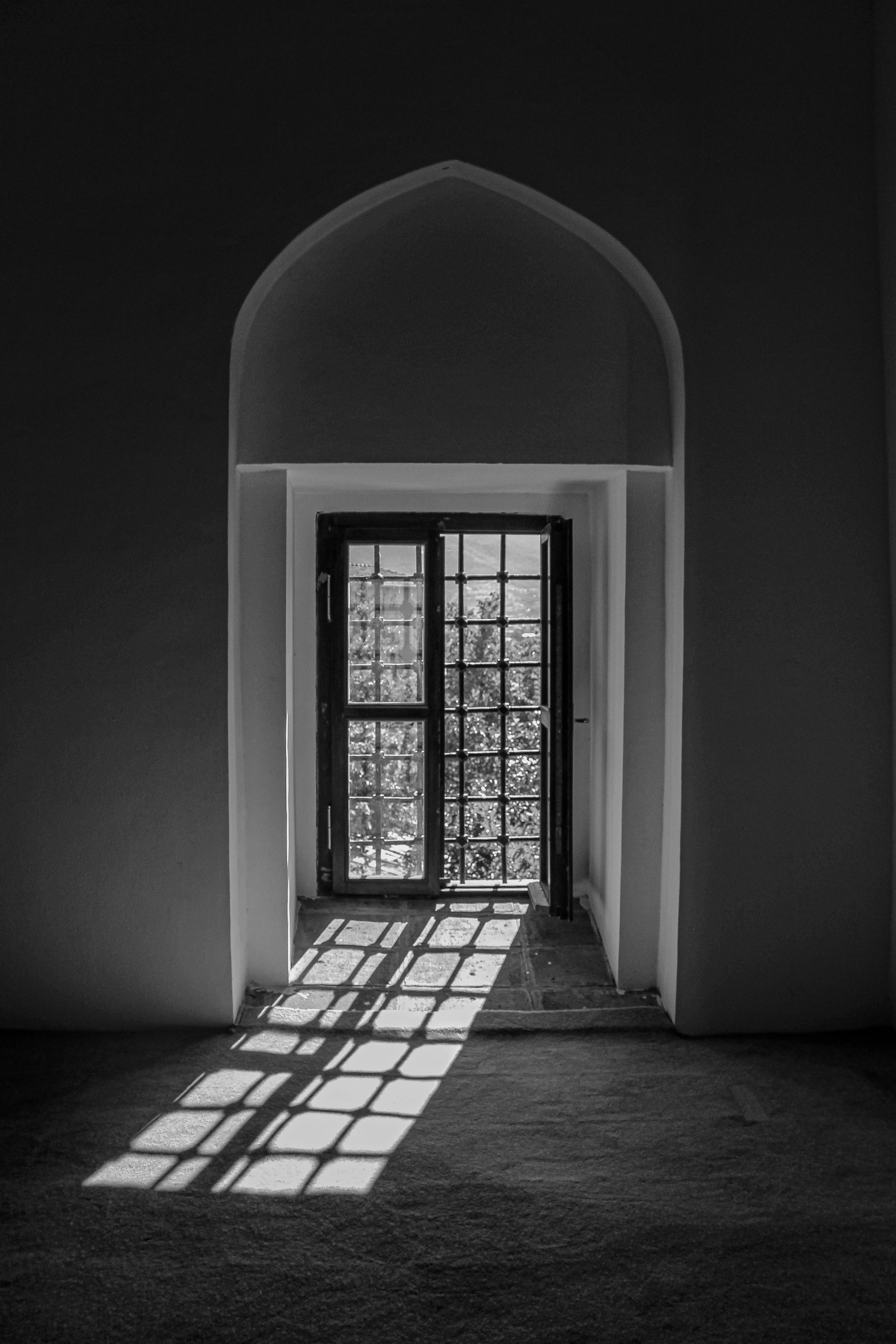 Man in Door Opening in Black and White · Free Stock Photo