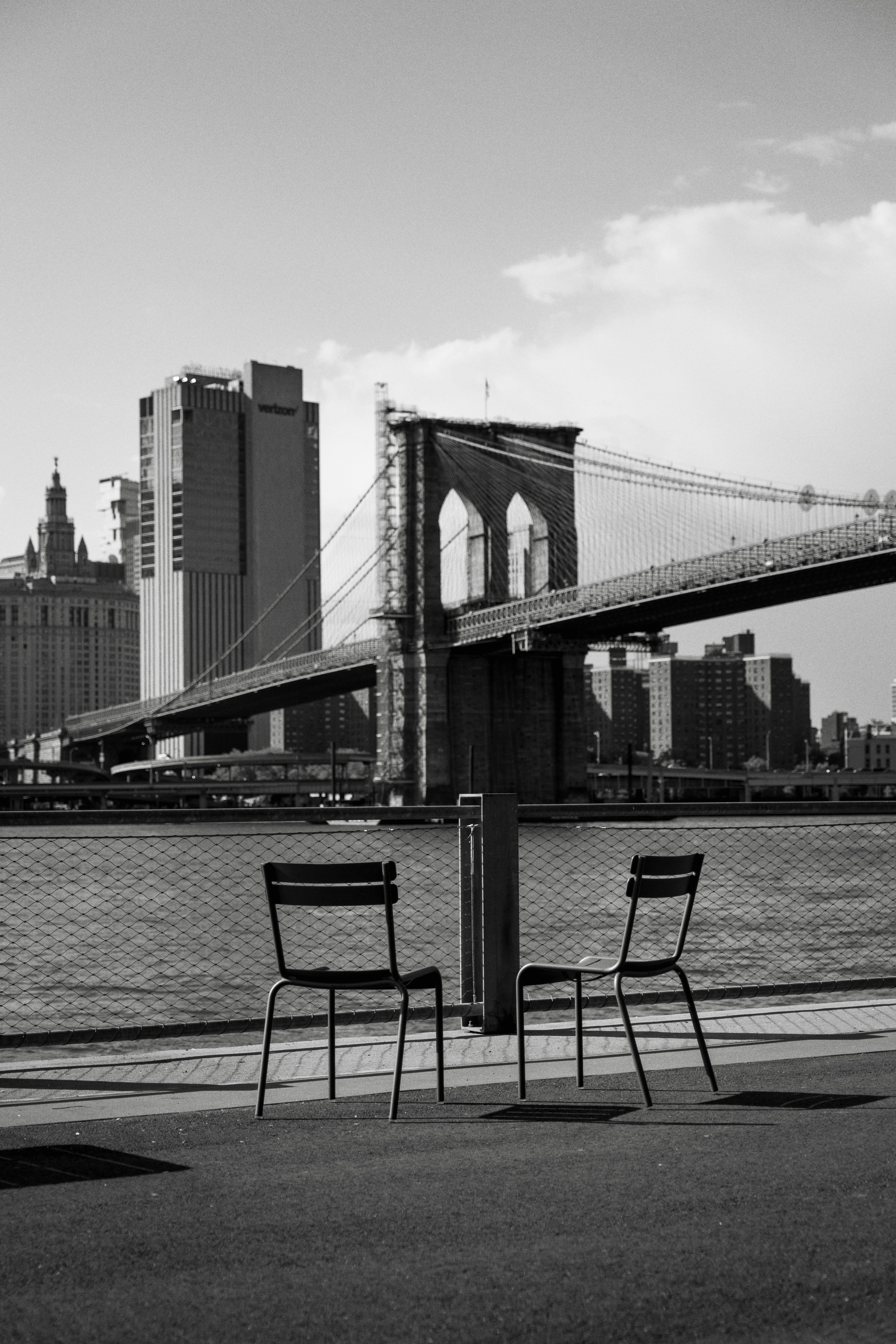 Two Chairs on Waterfront against Brooklyn Bridge · Free Stock Photo