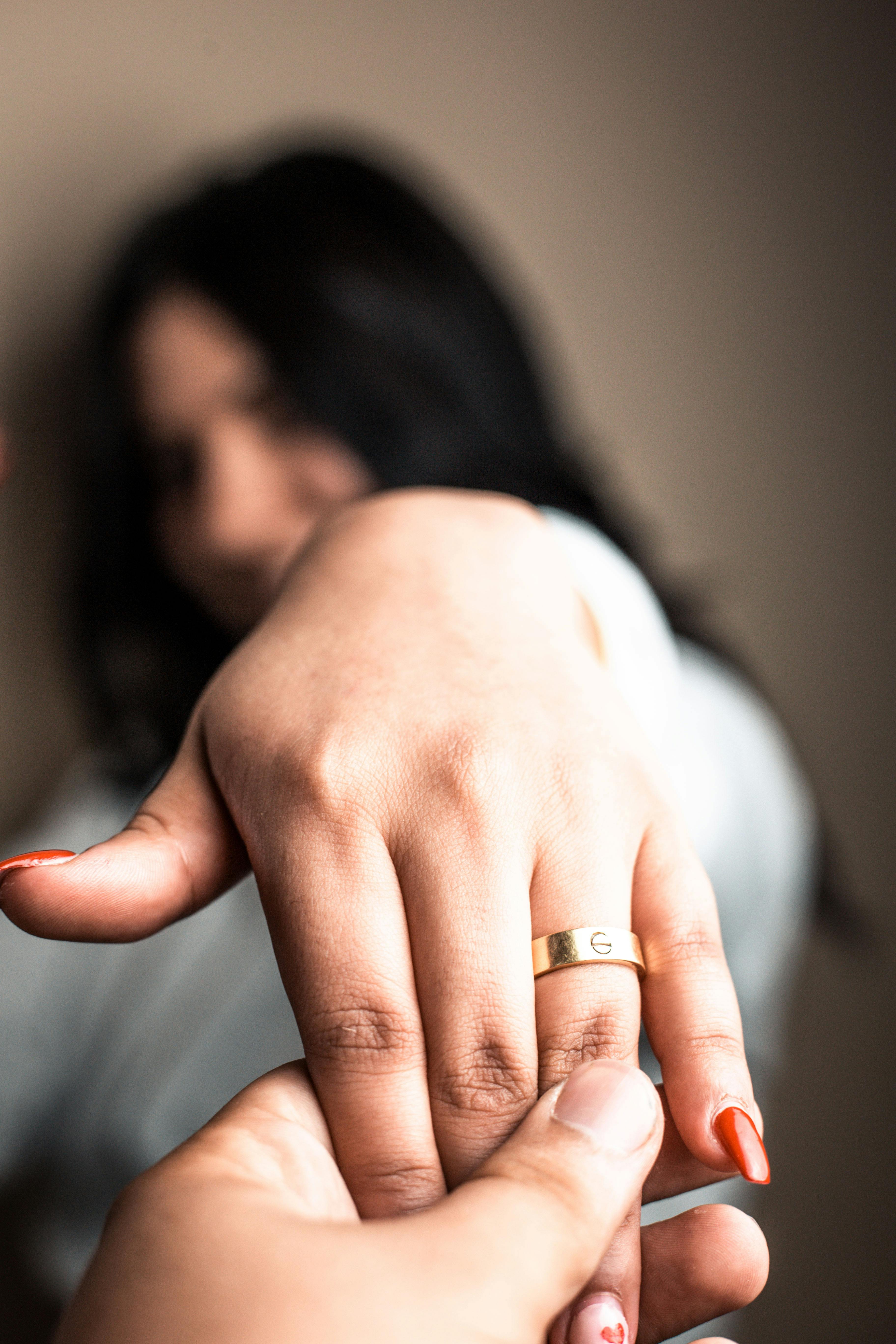 Hands with Engagement Ring on Embracing Man Head · Free Stock Photo