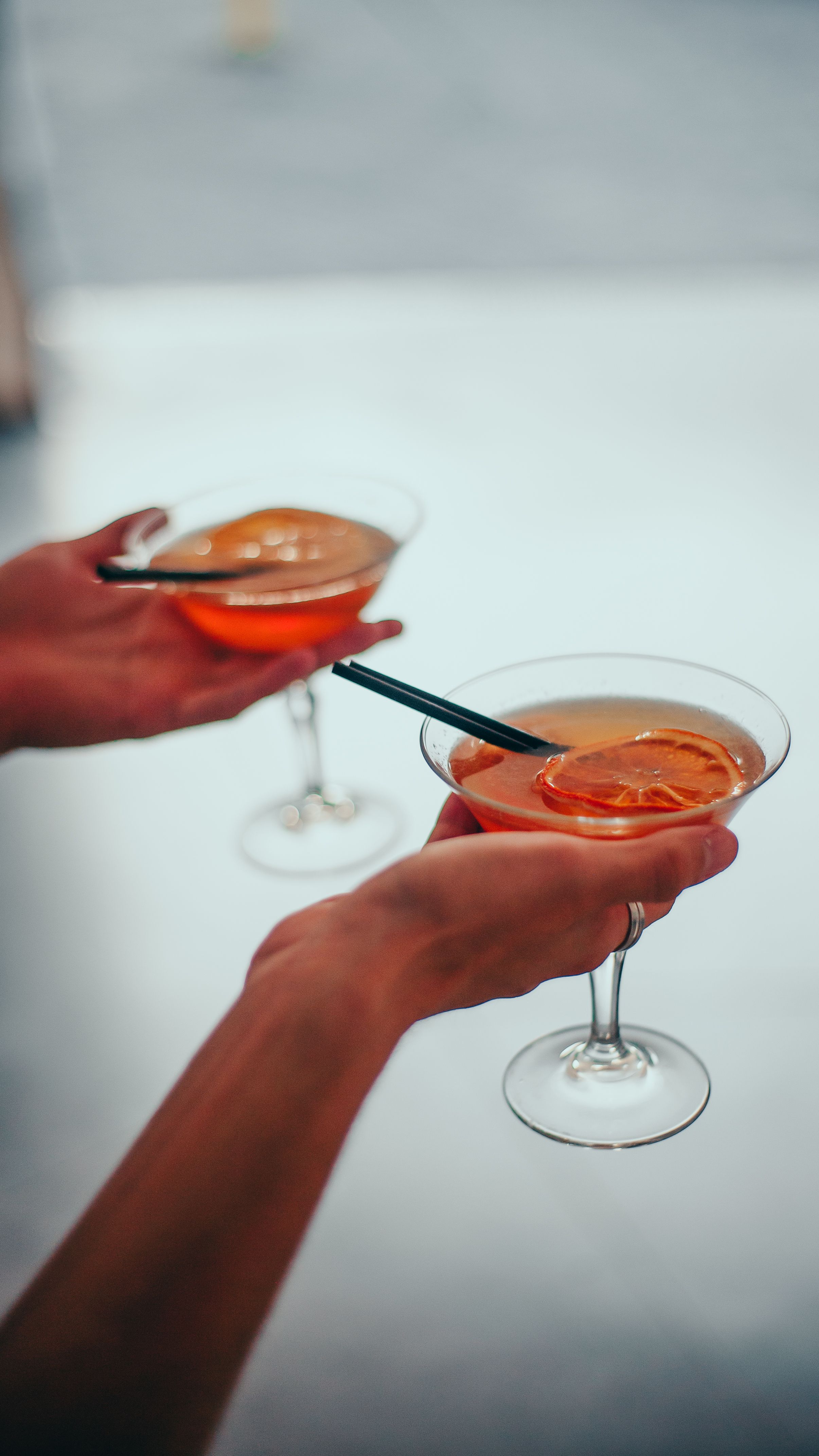 Hands Holding Drinks with Fruit Slices · Free Stock Photo